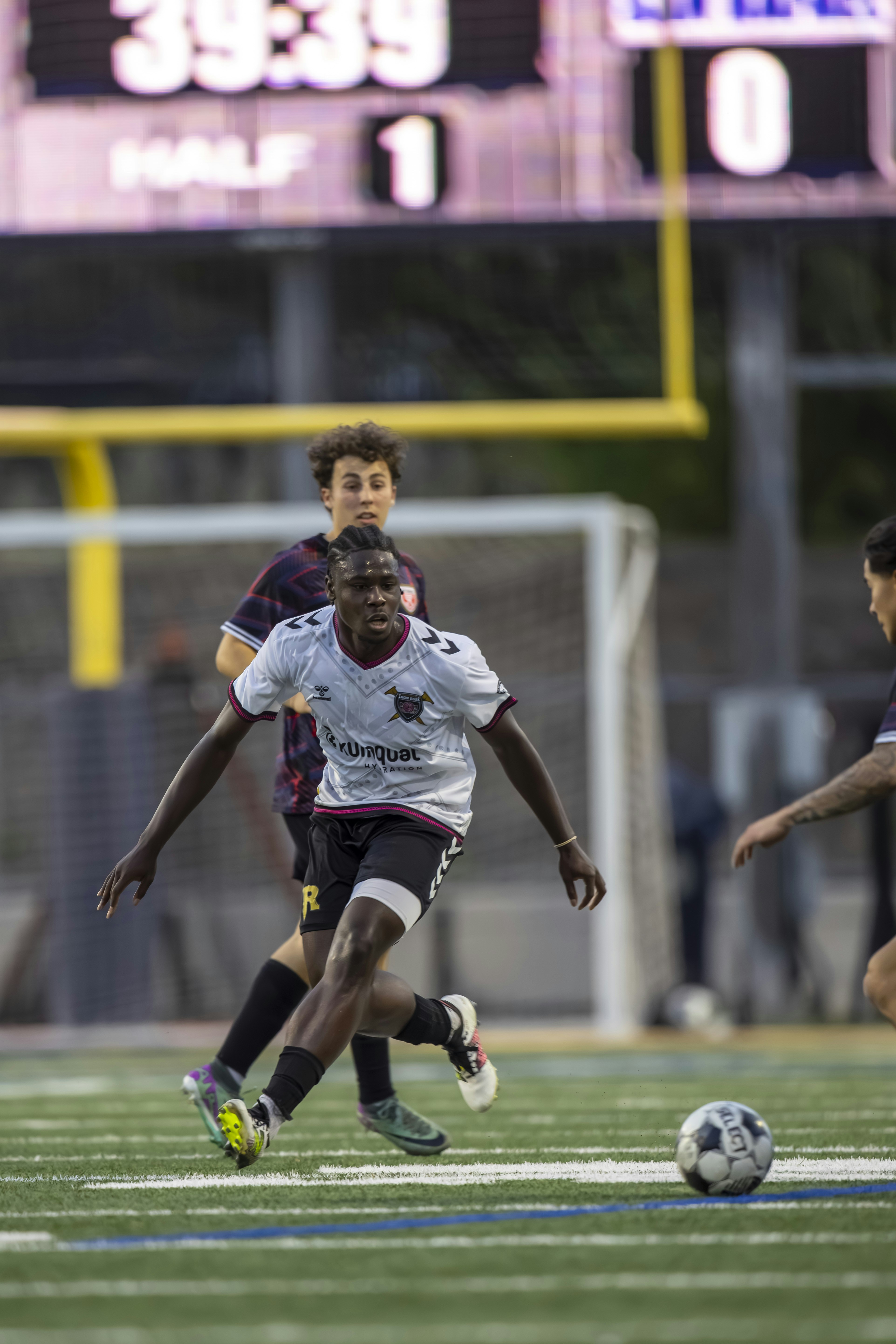 Dribble Under the Spotlight: A Forward in White Leads the Charge