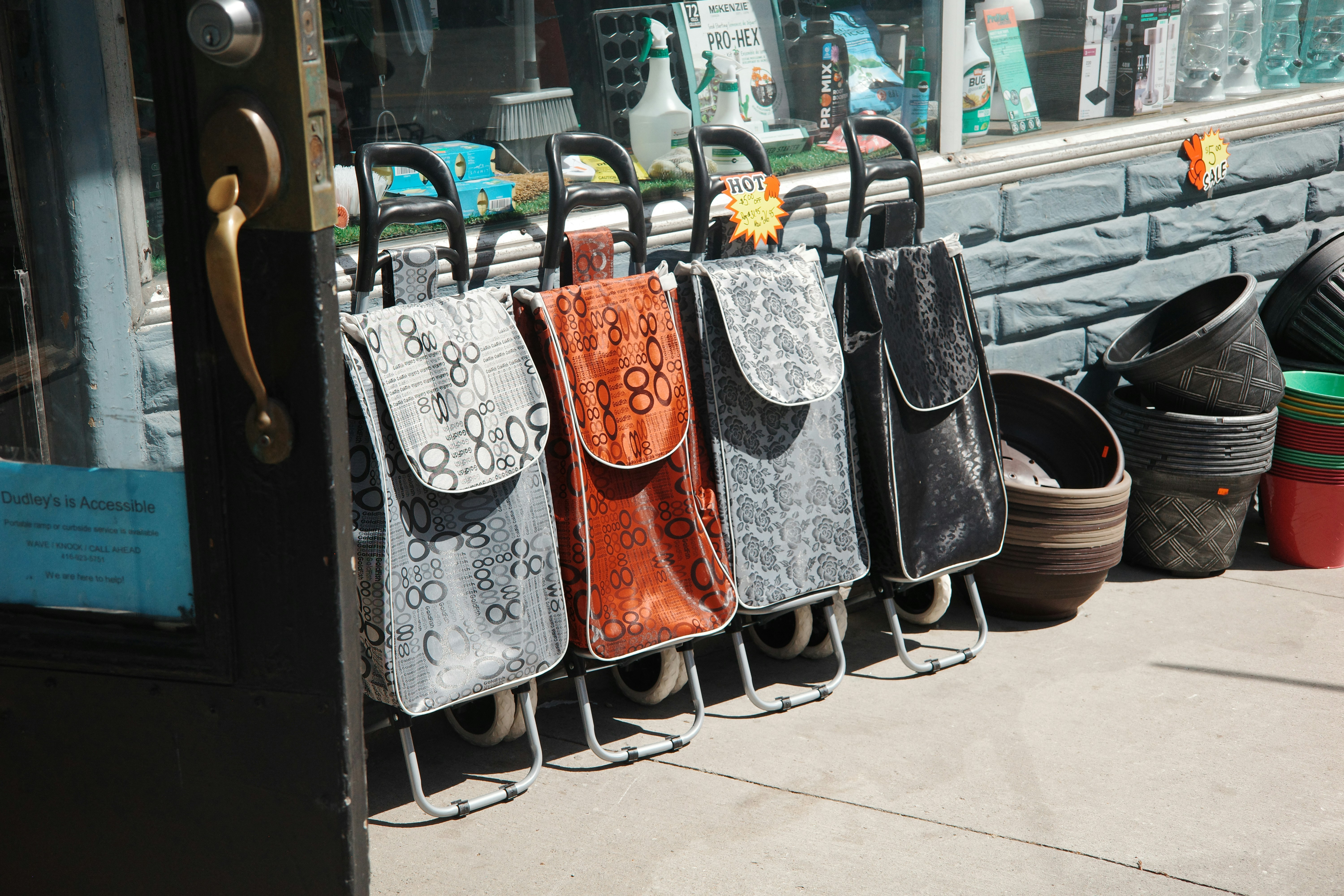 Colorful Sling Bags on a Metal Rack Outside a Shop