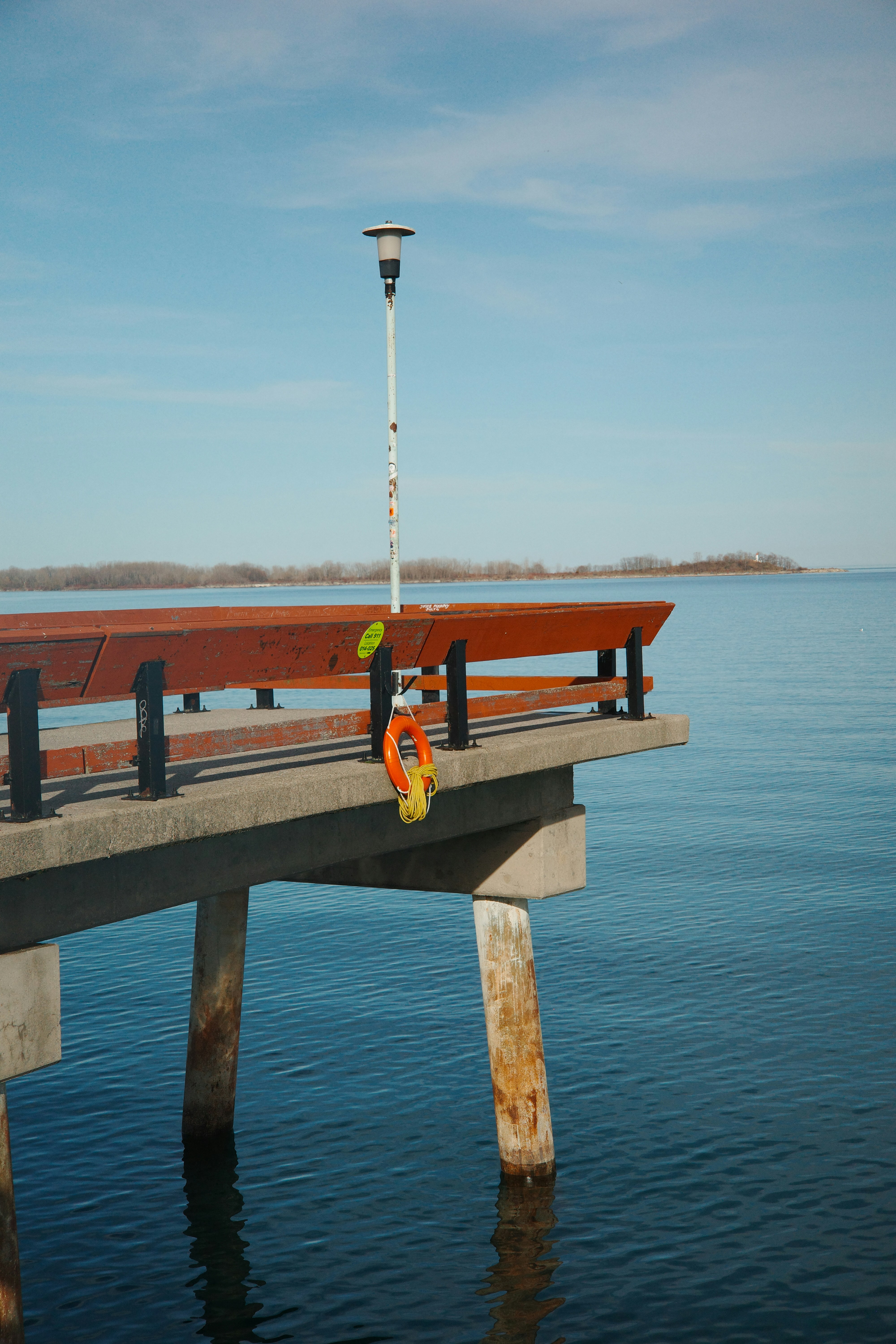 Lonely Pier: A Quiet Moment Over Calm Waters