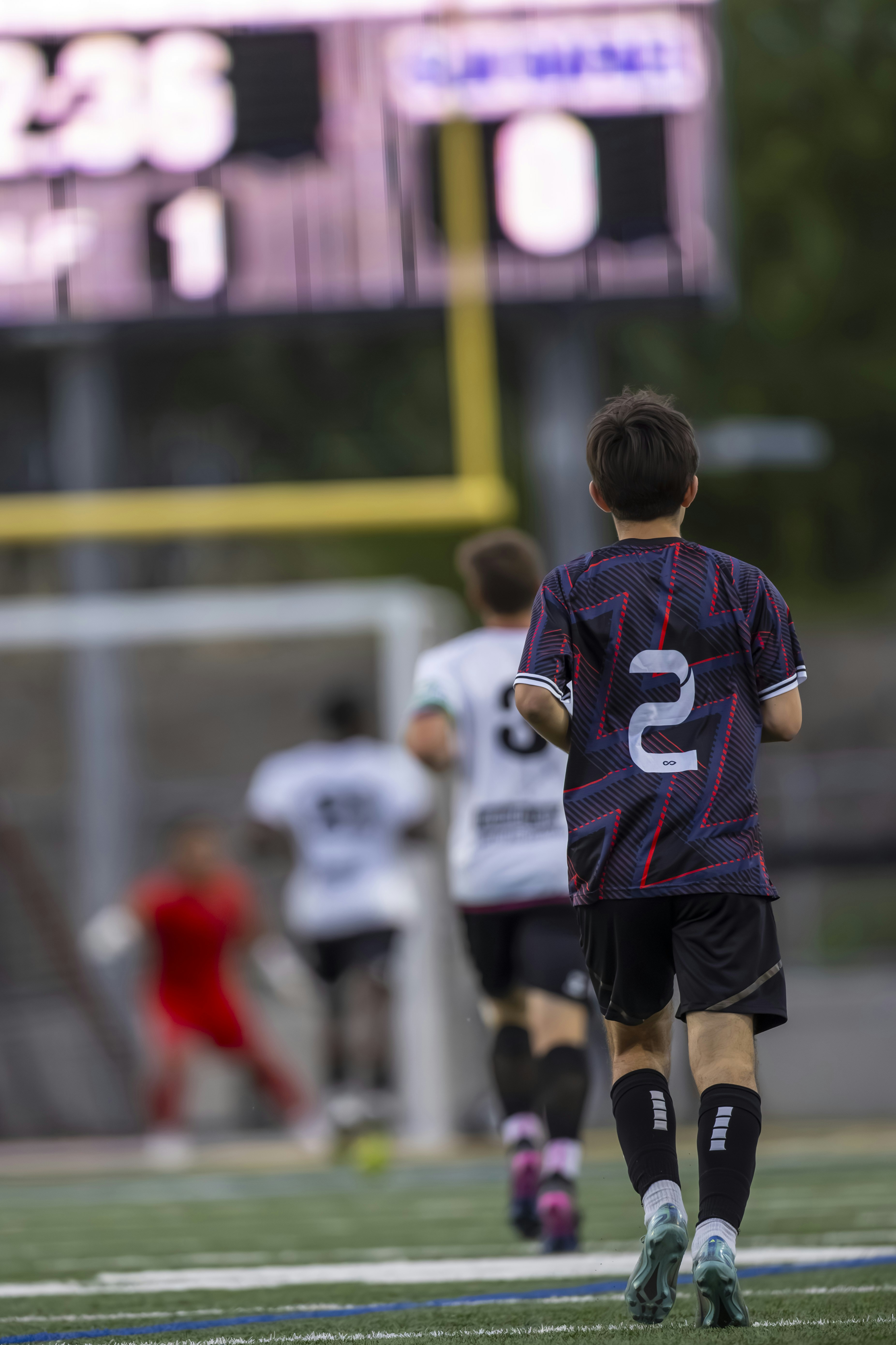 Runner in Focus: The Back-of-Jersy Moment on a Soccer Track