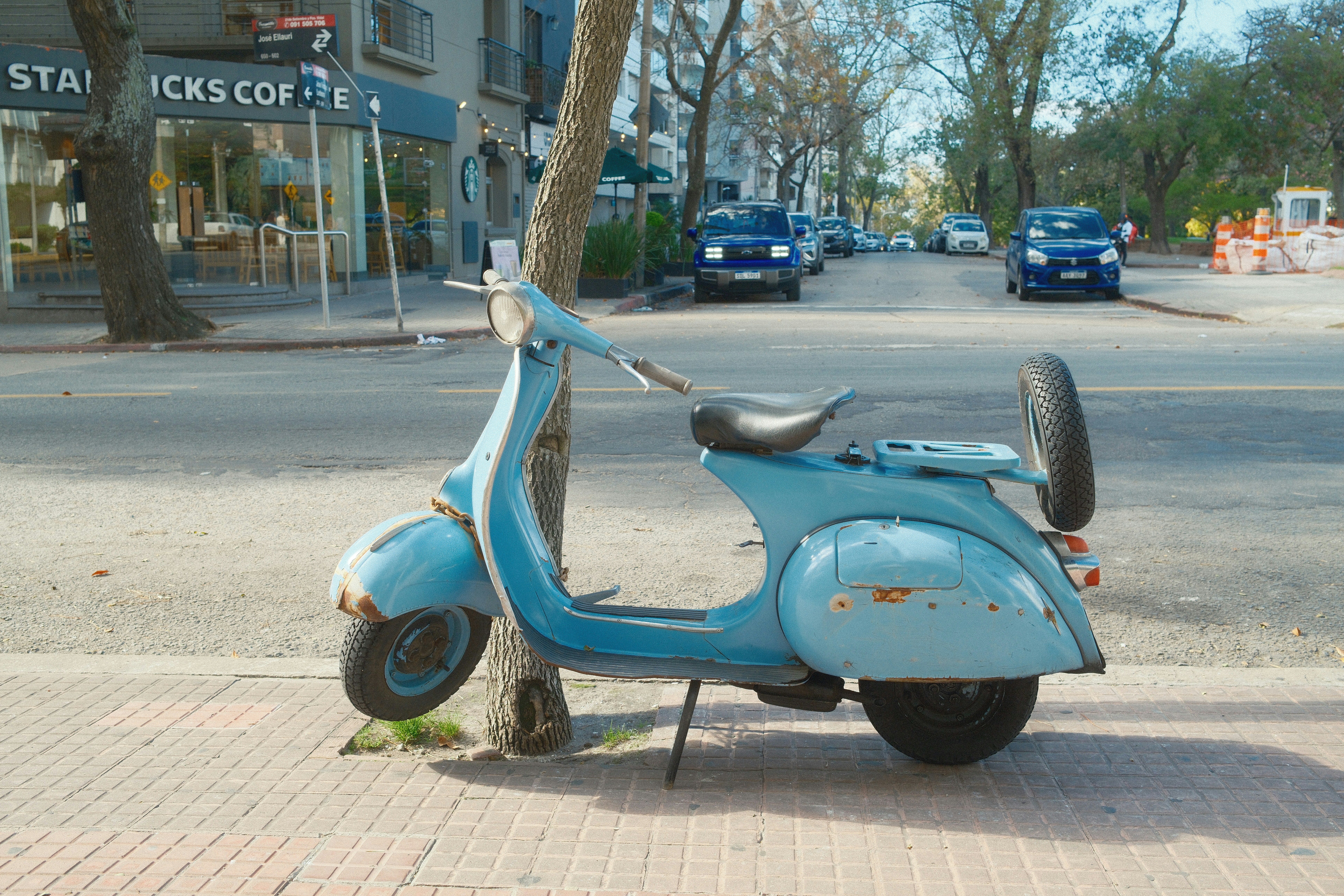 Pastel-blue Vespa by the Street