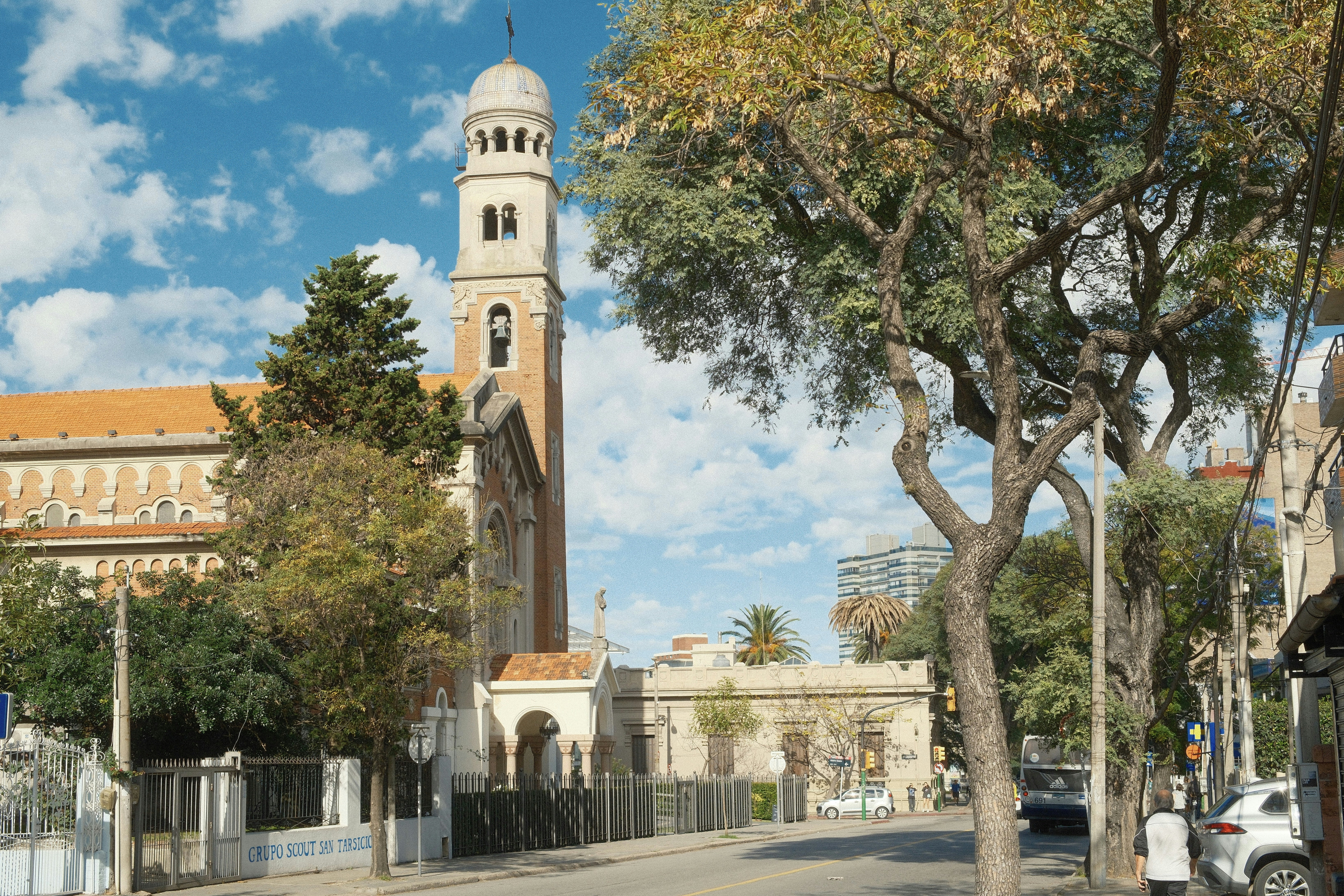 Bell tower and sunlit street: a quiet Mediterranean avenue