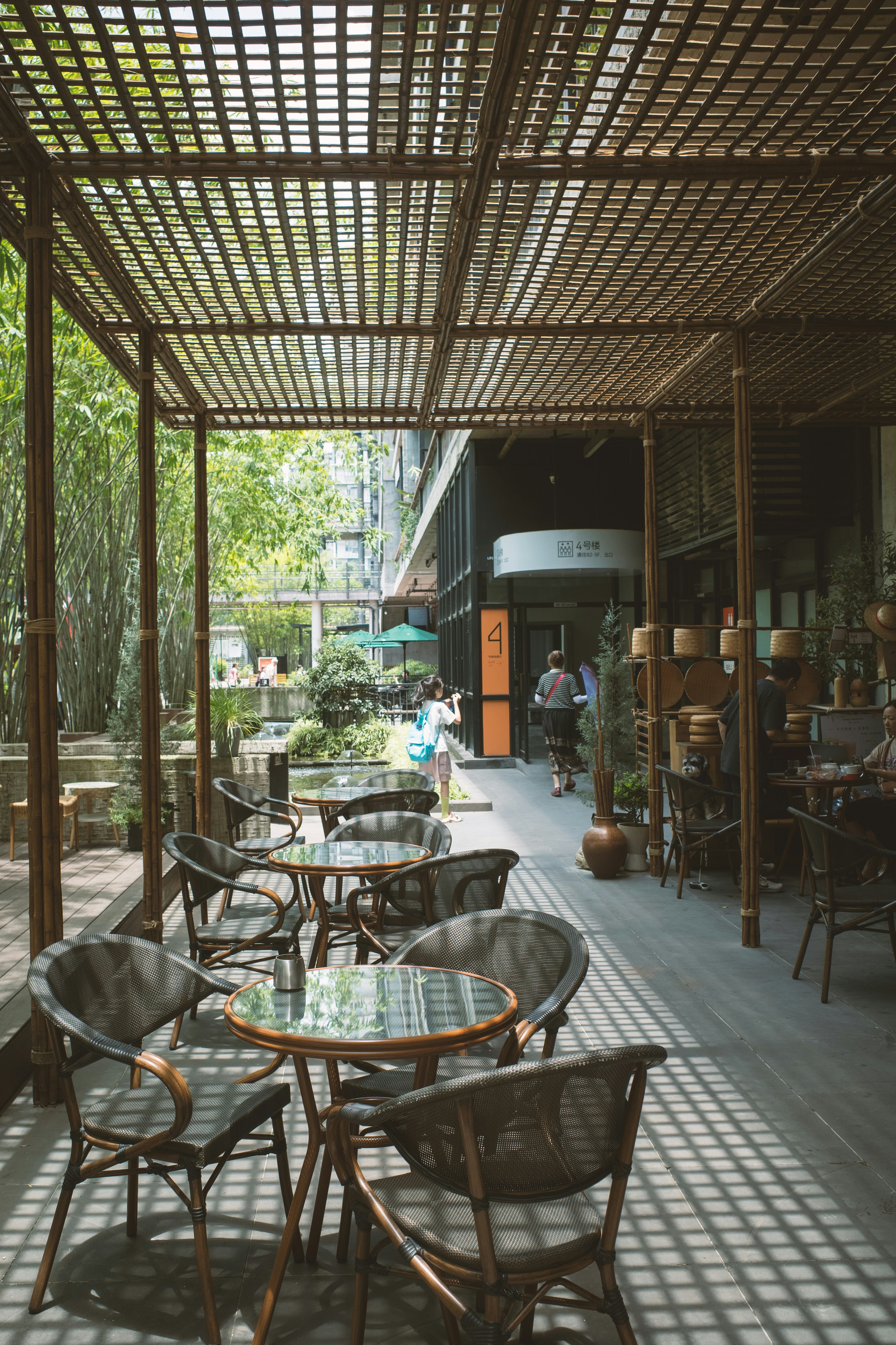 Shaded Courtyard Café Beneath a Lattice Canopy