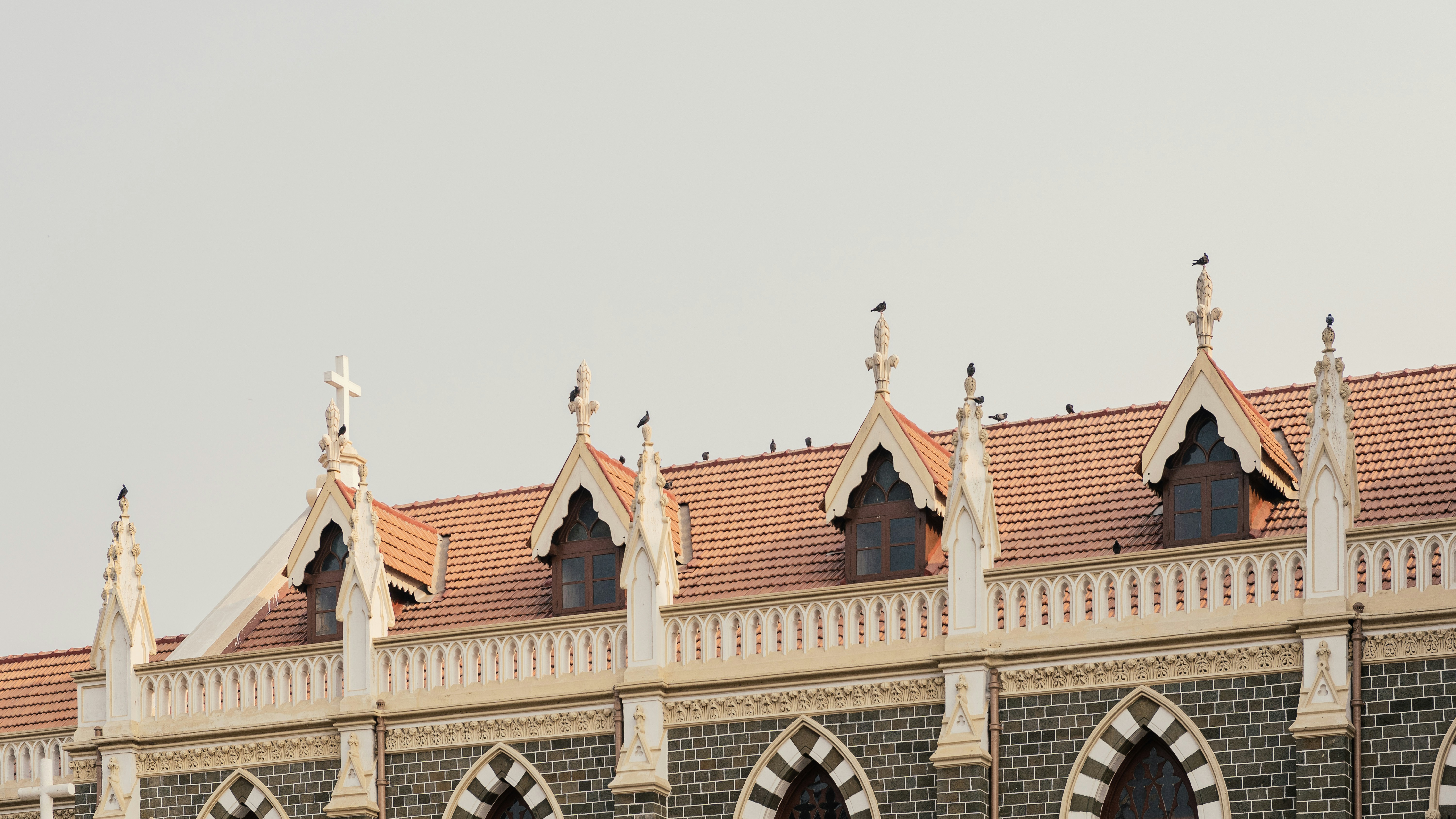 Gothic rooftop ridgelines under a pale sky