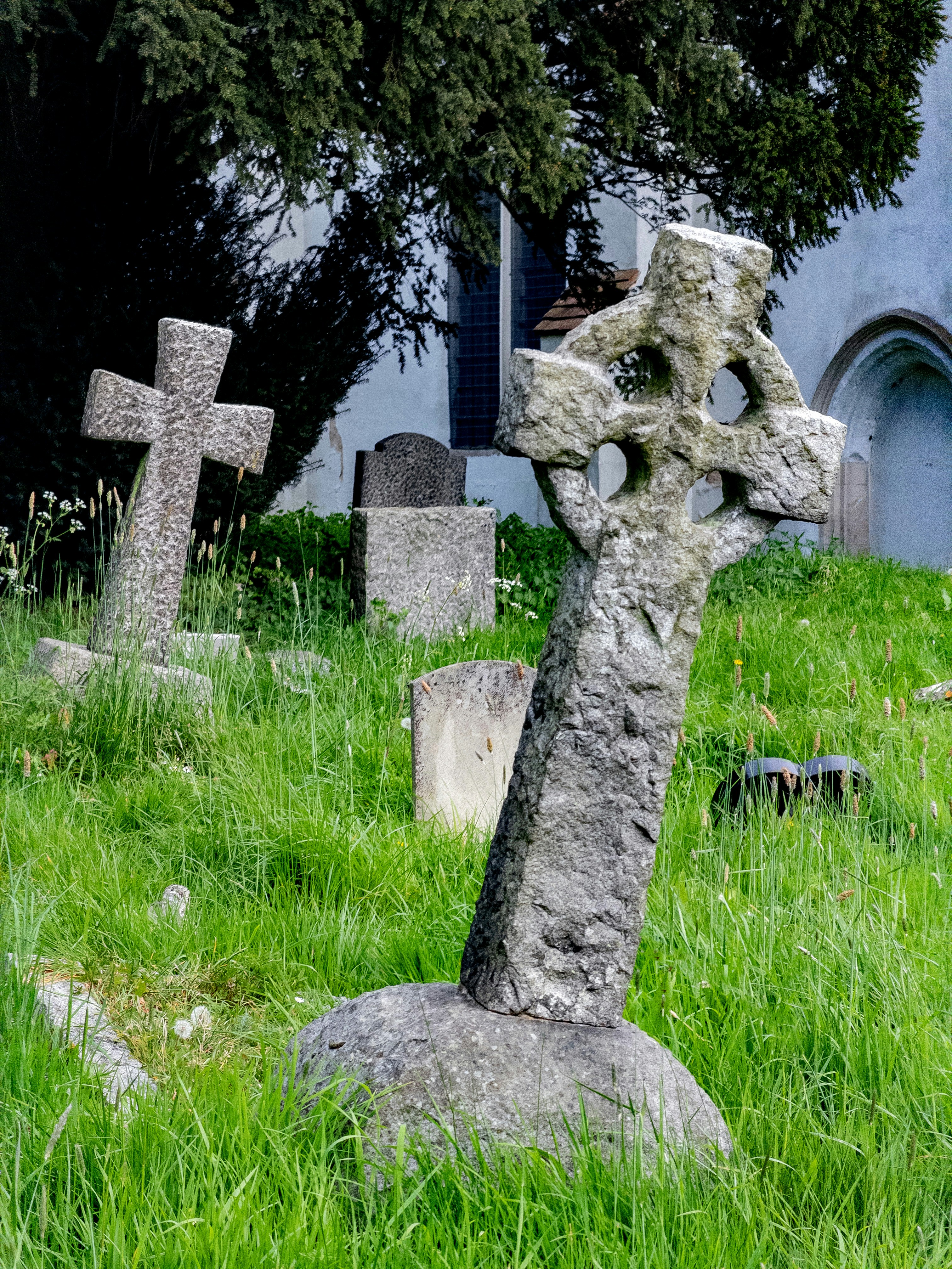 Weathered cross in a quiet churchyard
