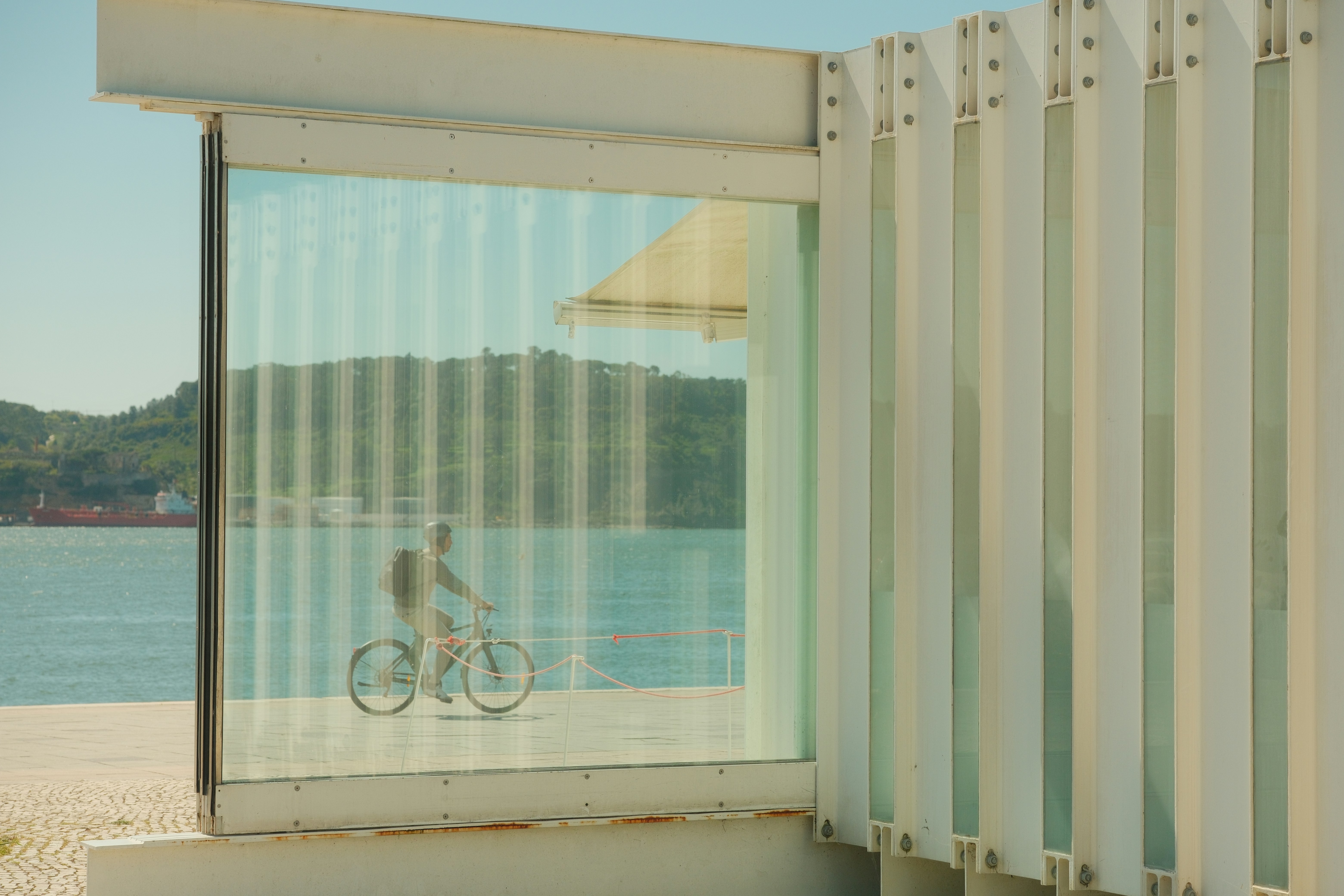 Glass Gatehouse Over the Waterfront: A Quiet Ride Past a Coastal Corridor