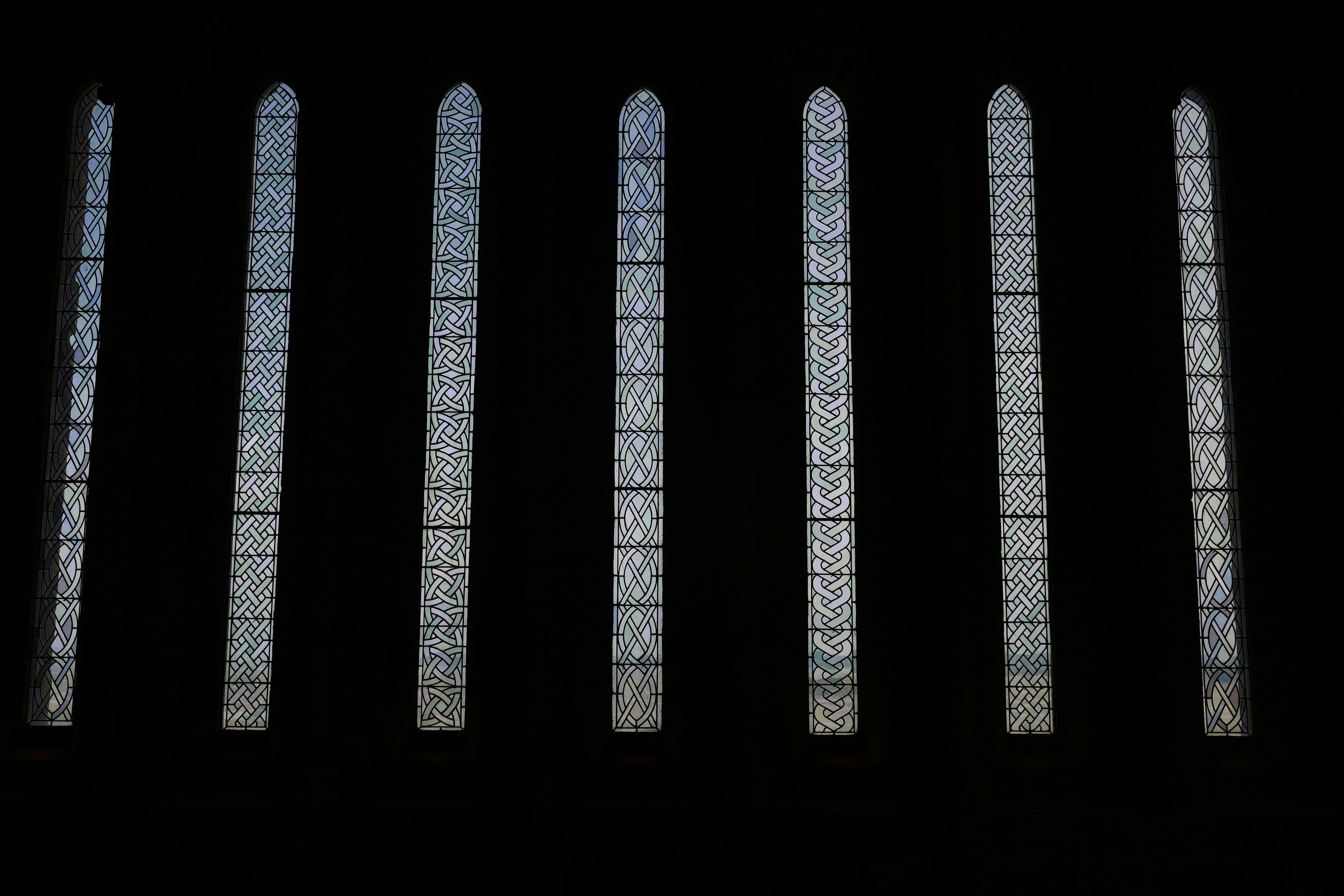 Silent Cathedral of Glass: Morning Light Through Vertical Tracery
