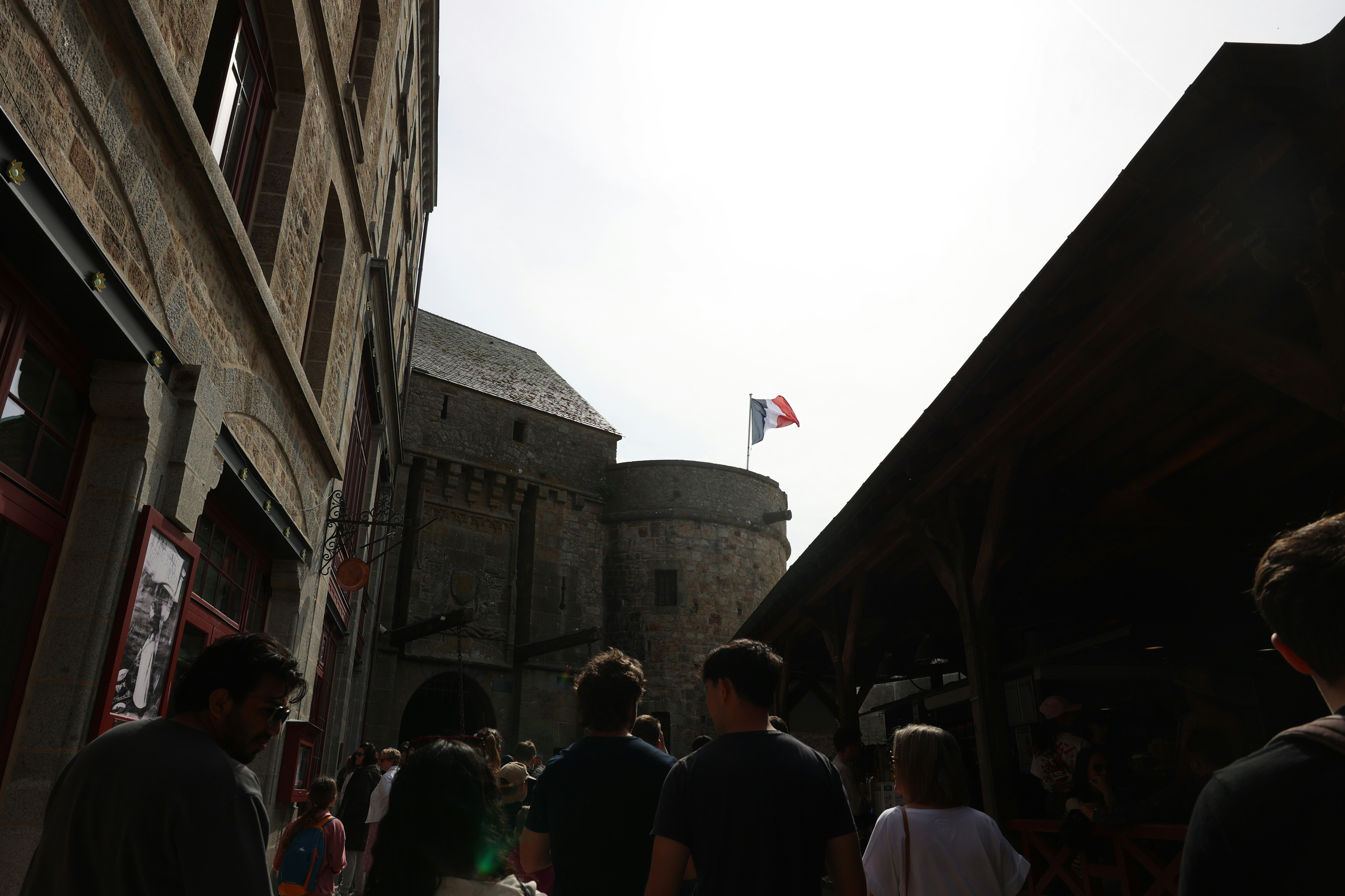 Castle Courtyard Pulse: A Crowd Beneath Stone Turrets