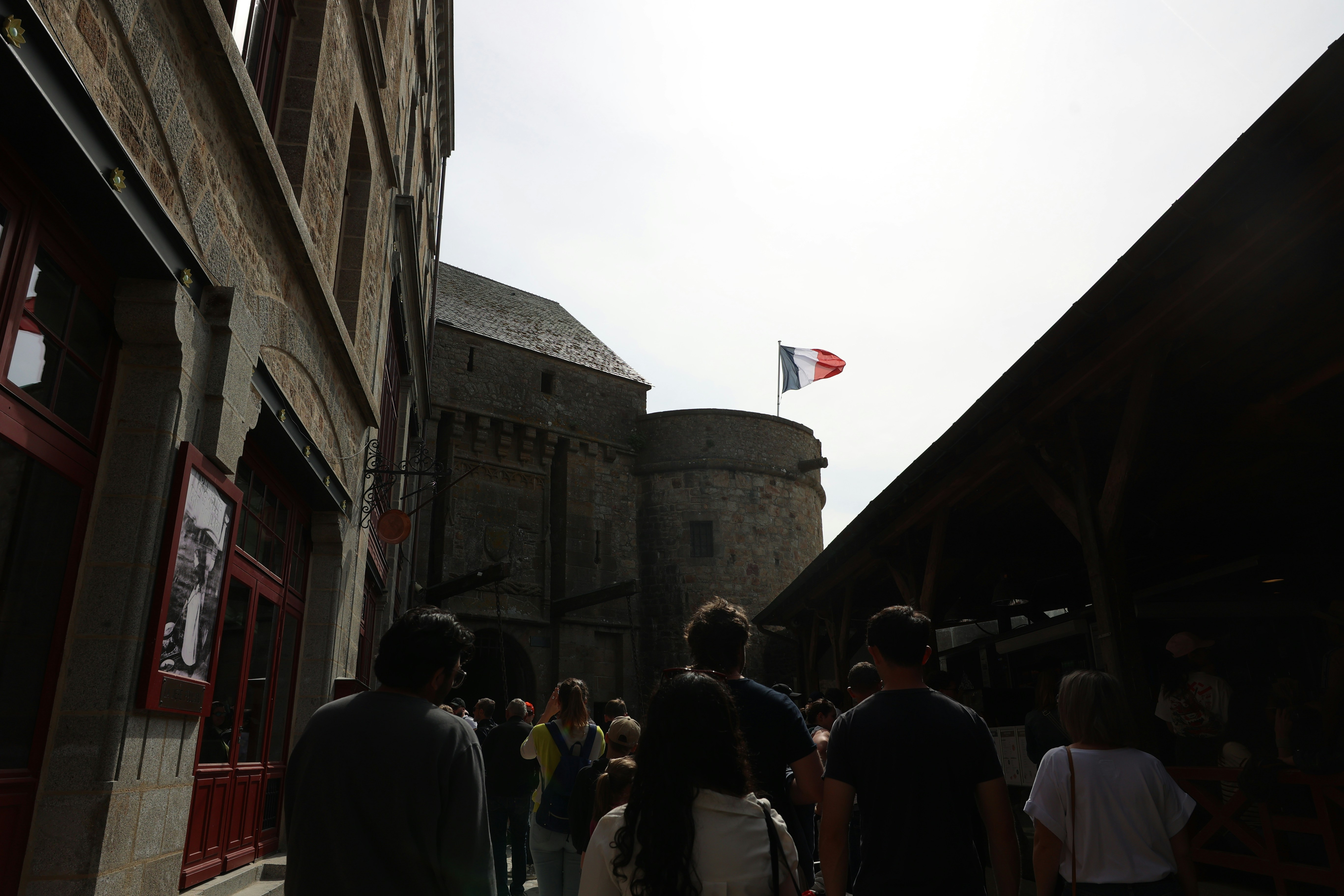 Flag over the Medieval Gate: A Quiet Clasp Between Stone and Sky