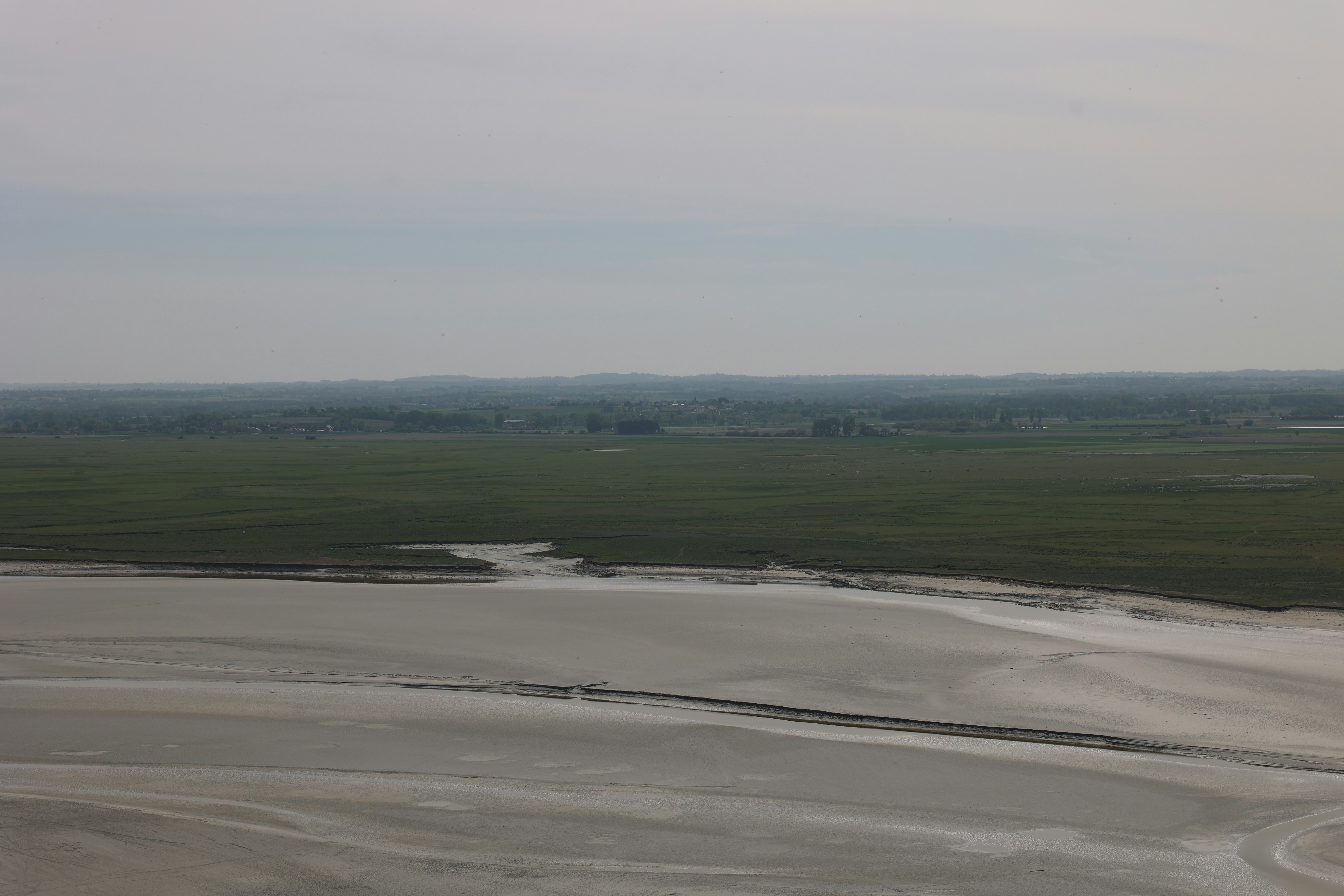 Flat Salt Flats Meet Distant Green Plains