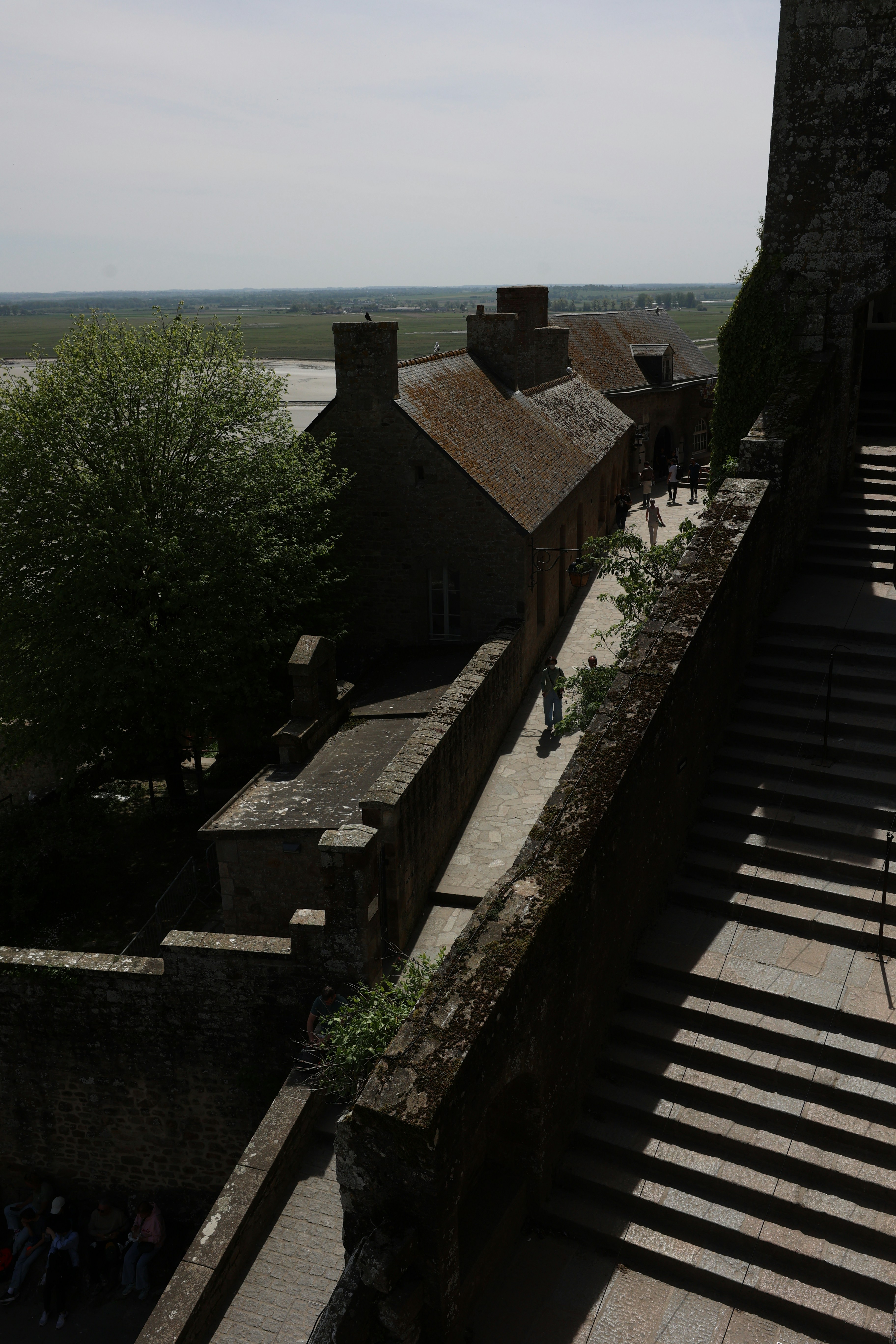 Castle Battlements: Sunlit Path Along A Stone Rampart