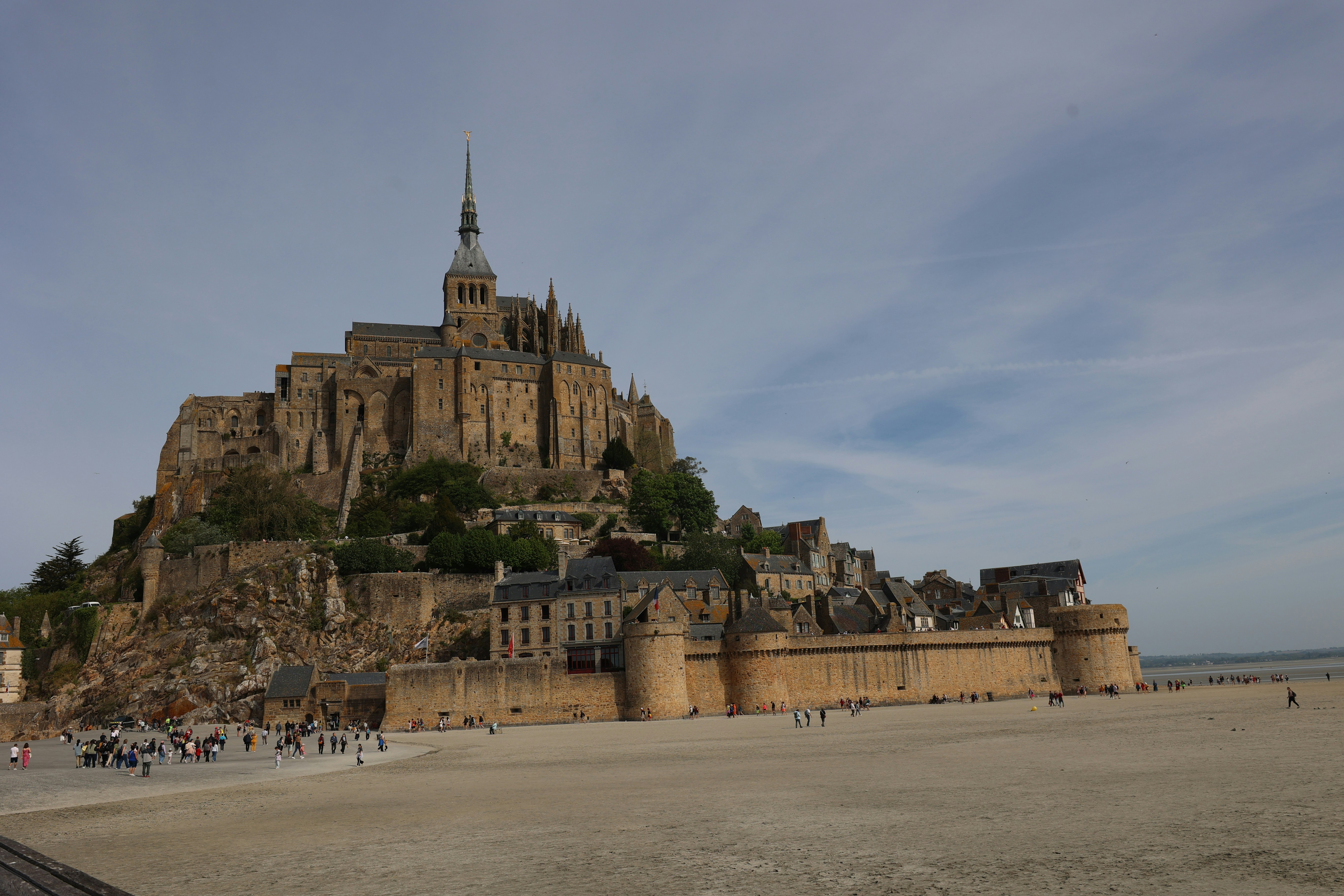 Mont Saint-Michel: fortress, village, and sea wall under a soft sky