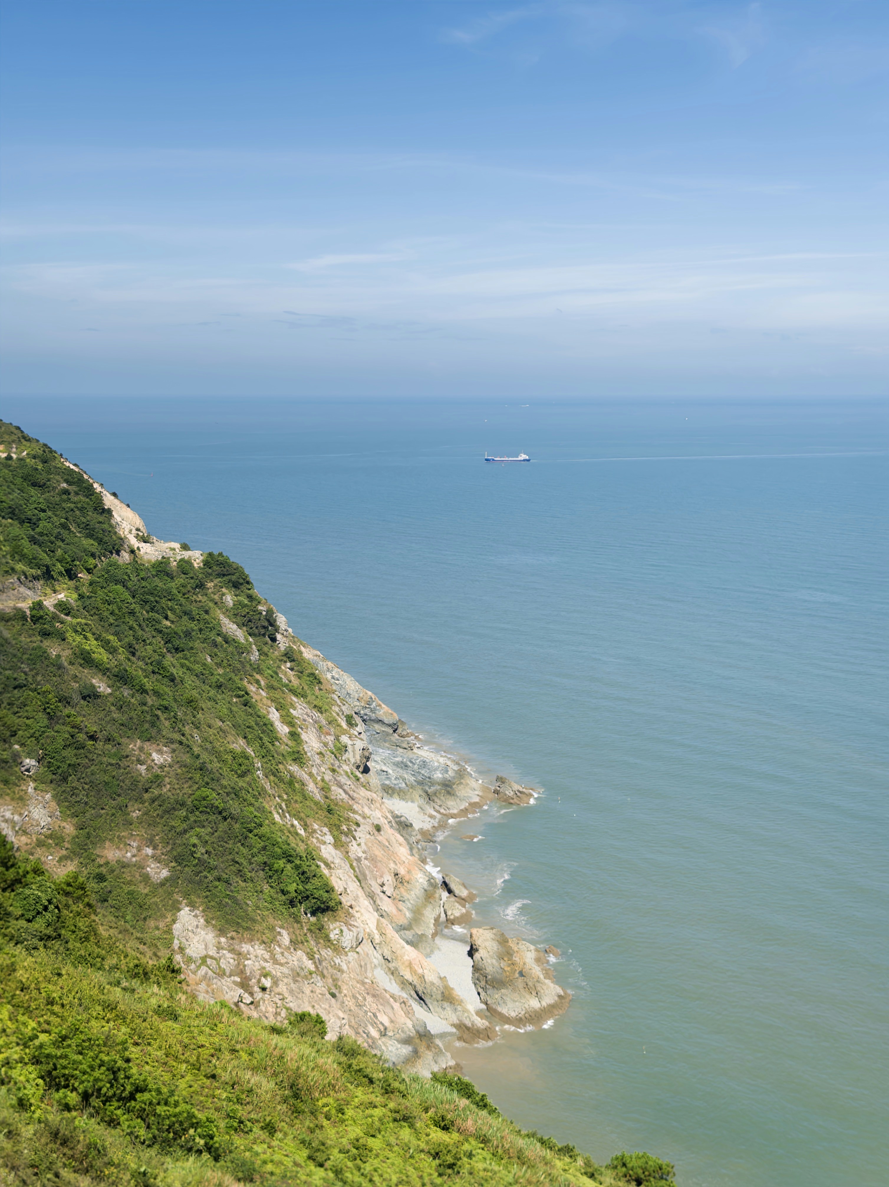 Cliffside Aegean Vista: A Ship on Calm Seas