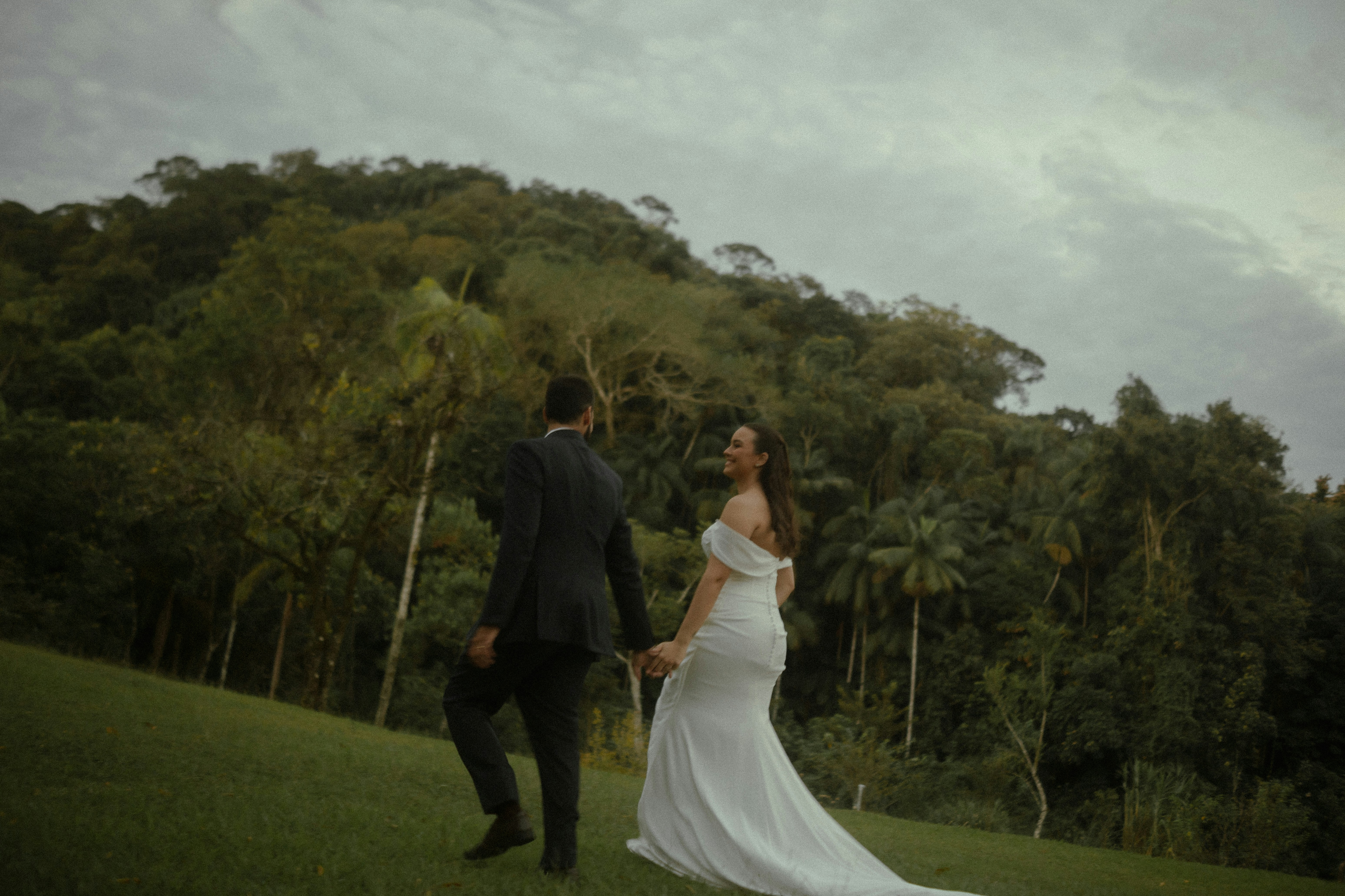 White Dress, Green Canon: A Couple Steps Into the Sunset on the Lawn
