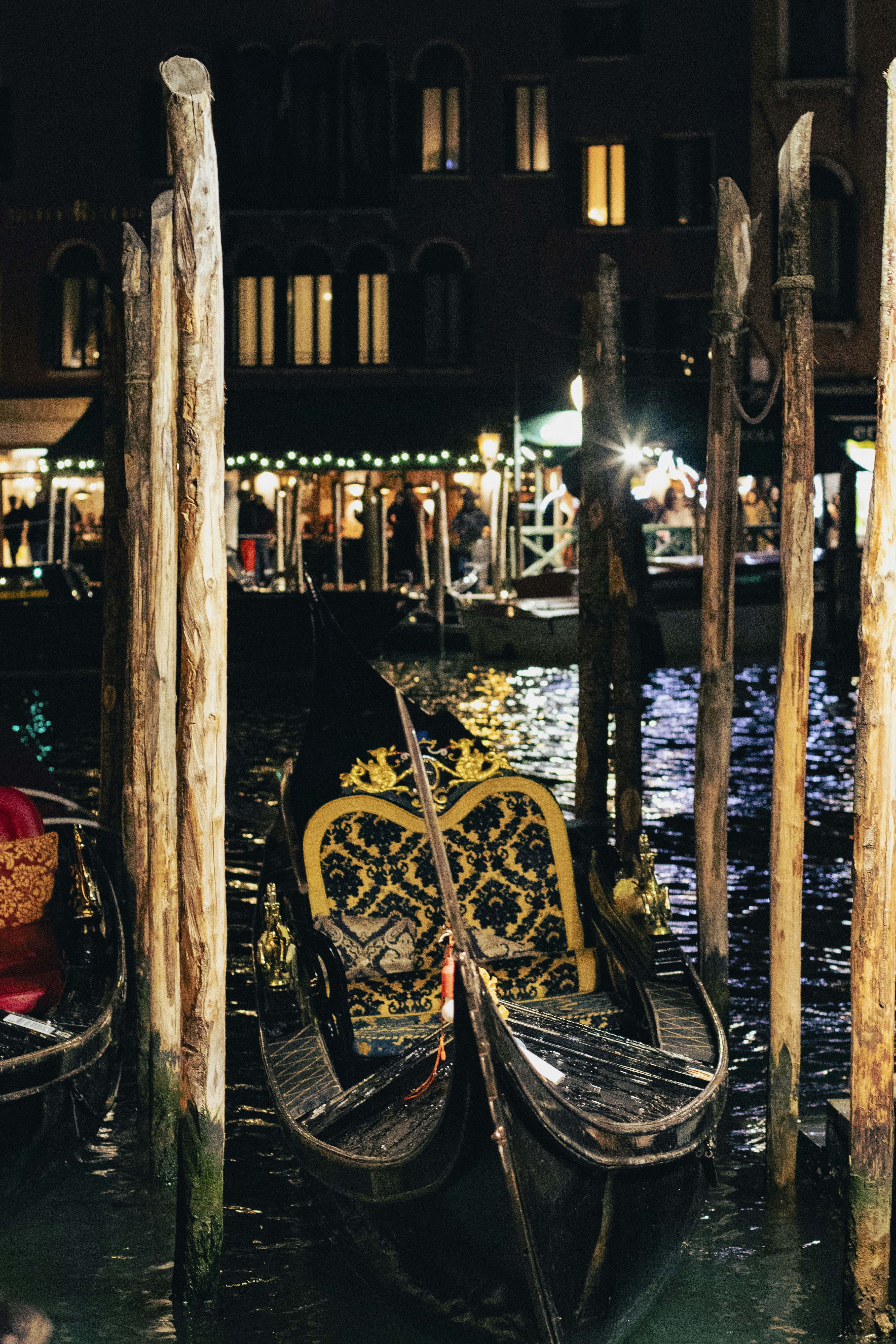 Gondola at Dusk: A Venetian Moment by the Mooring Posts