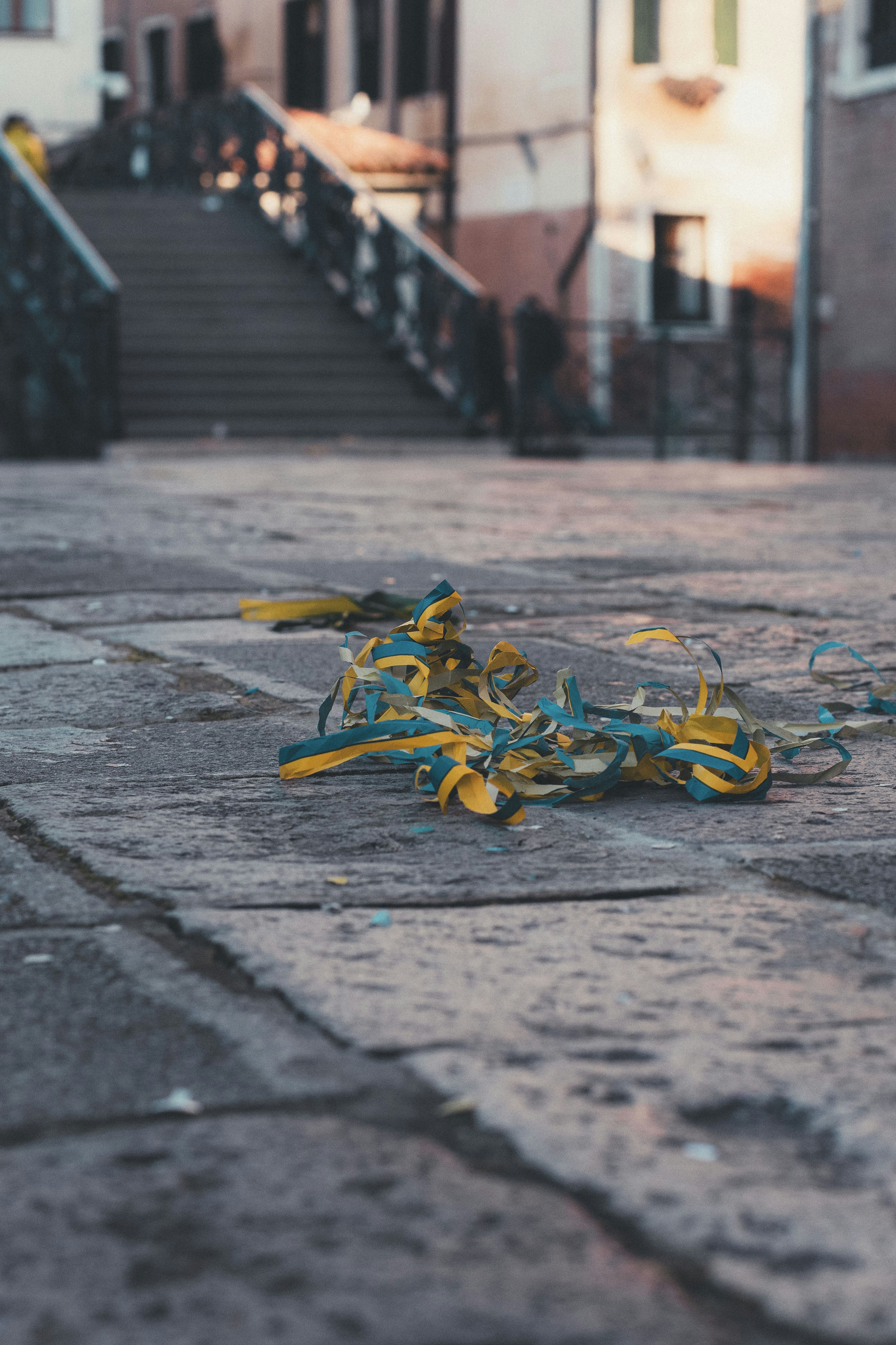 Tied Blue and Yellow Remnants on a Quiet Street