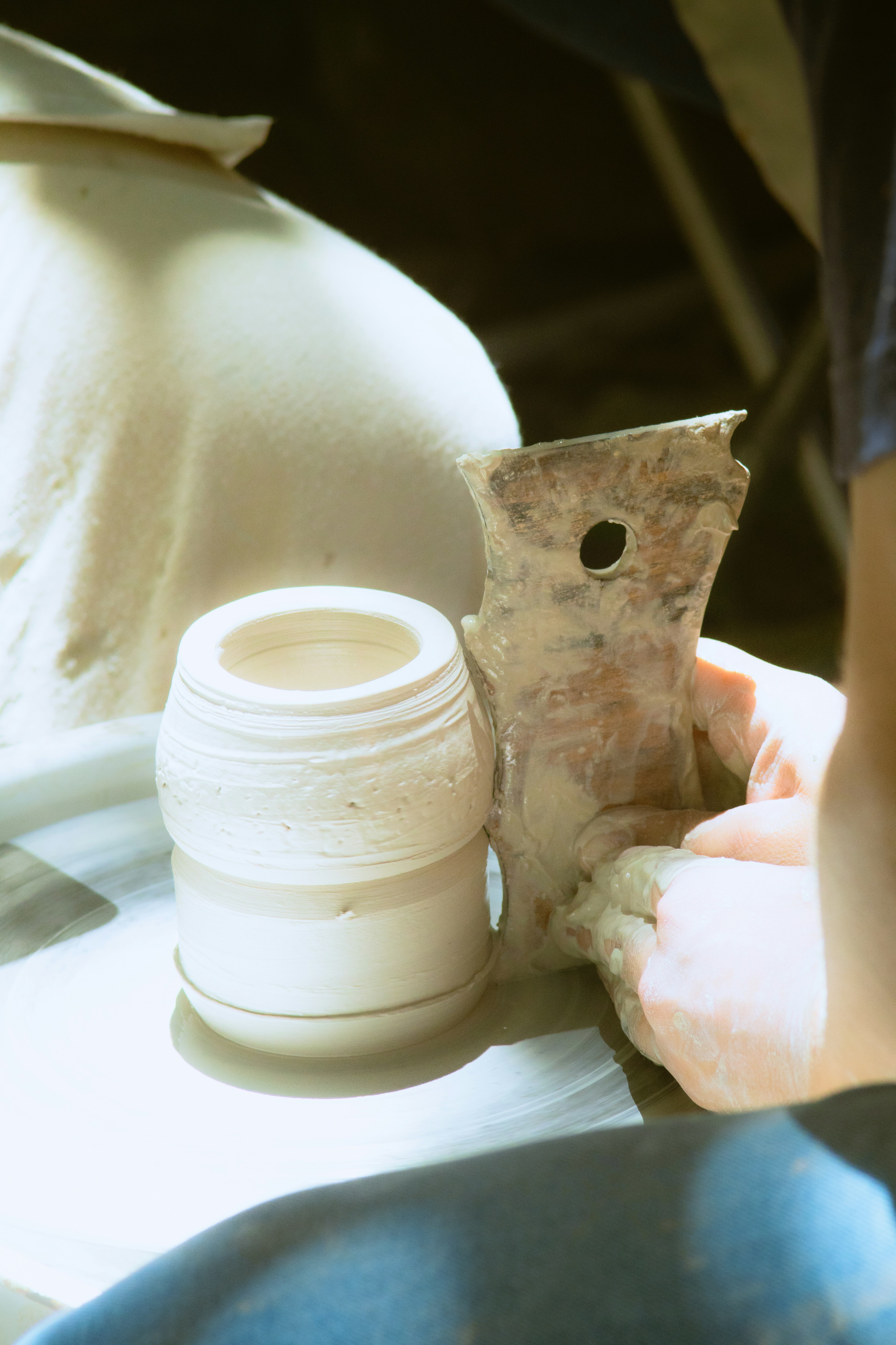 Clay Vessel on the Wheel: Hands shaping a Pottery Form