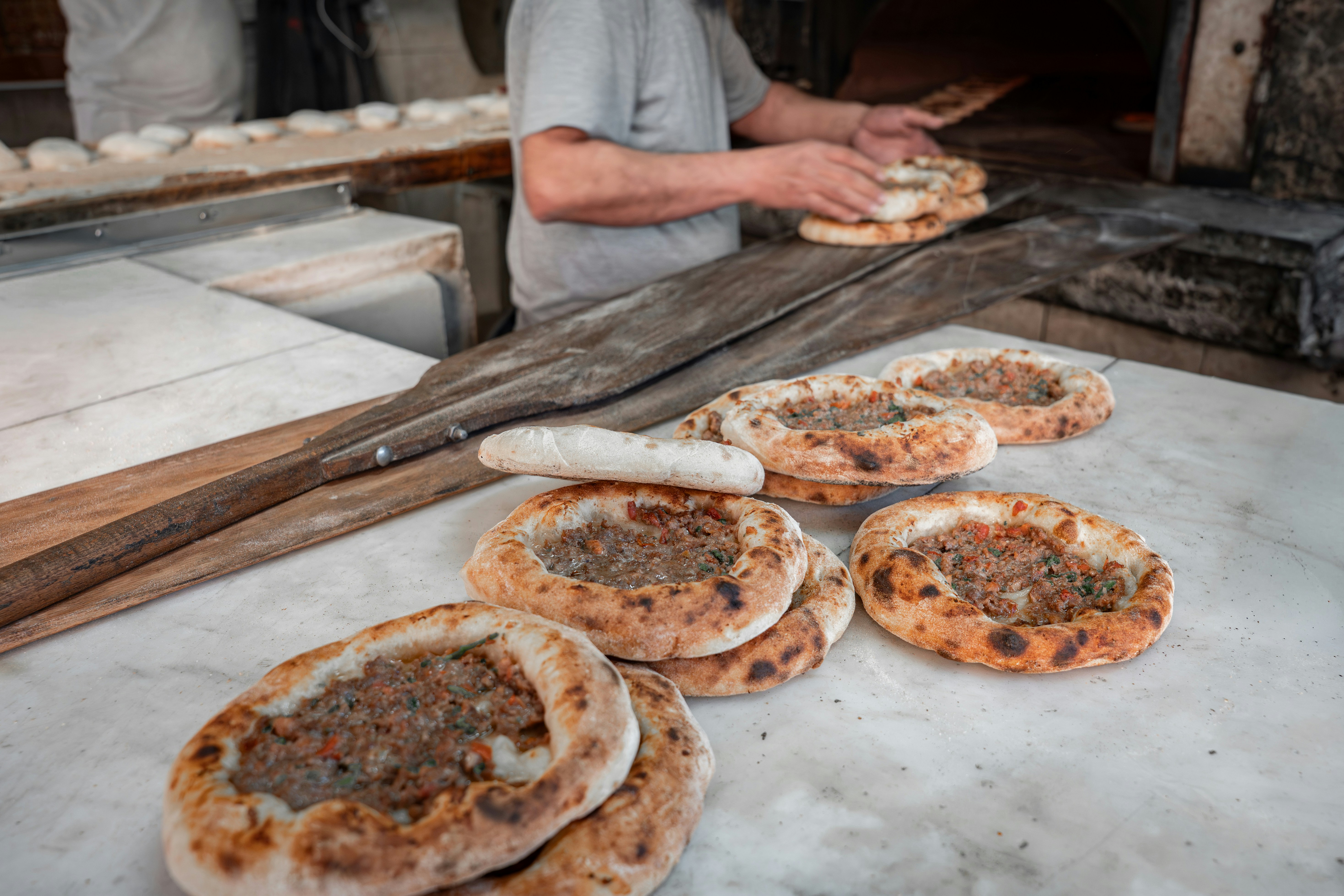 Stone-fired Pizzas Cool on a Marble Counter