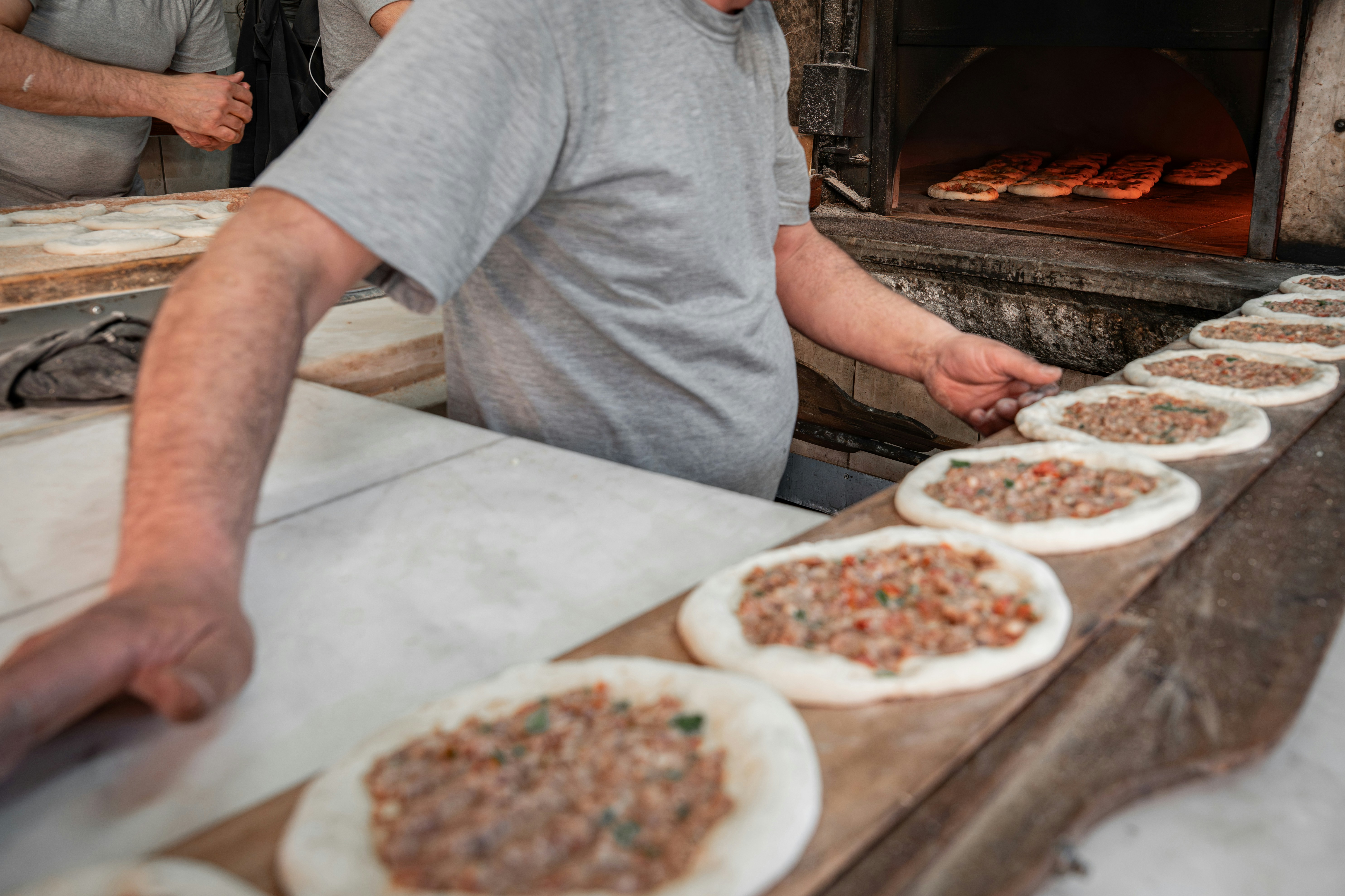 Line of Mini Pies On a Taqueria Conveyor
