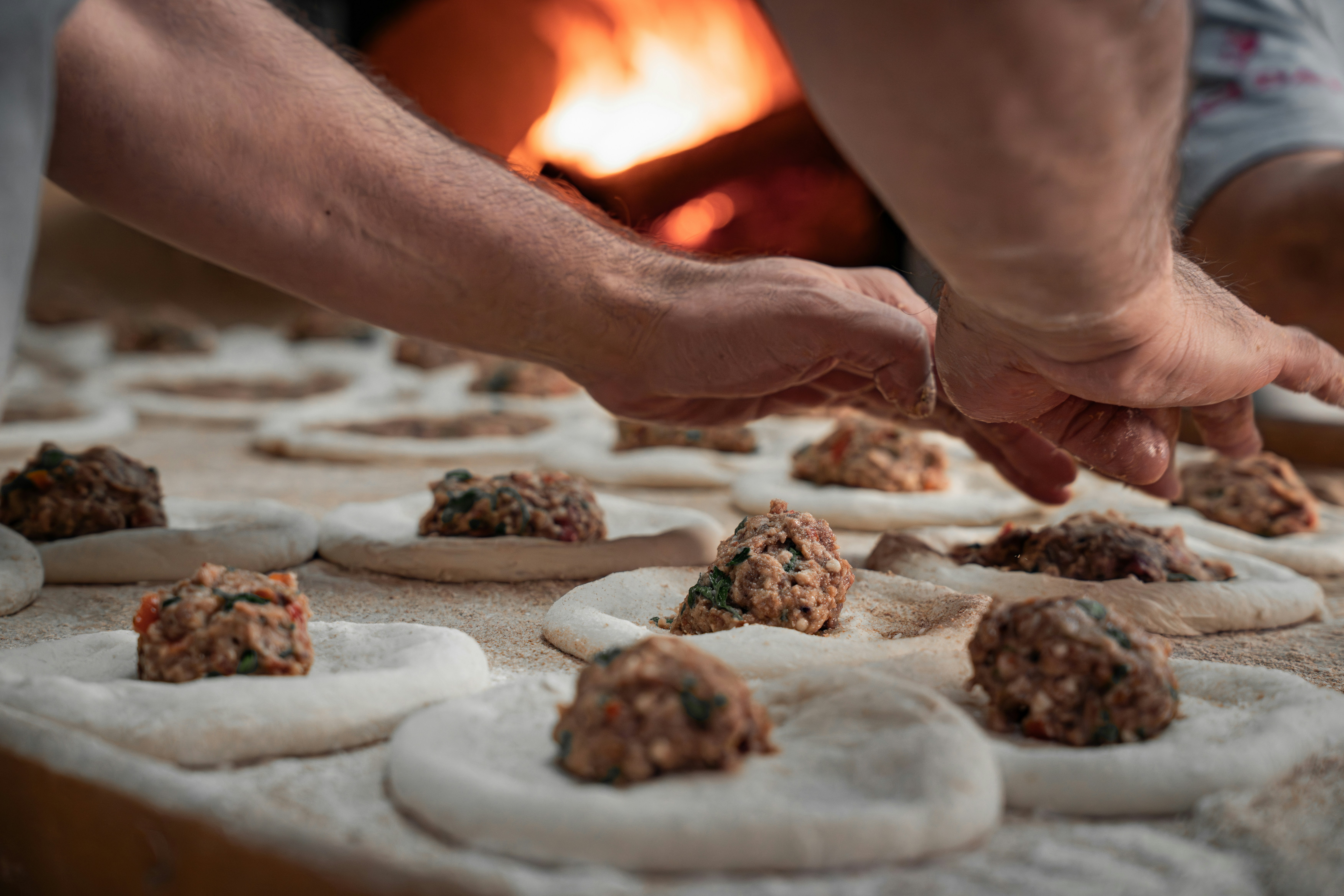 Hands on Dough: Shaping Mini Pizzas Near a Hearth