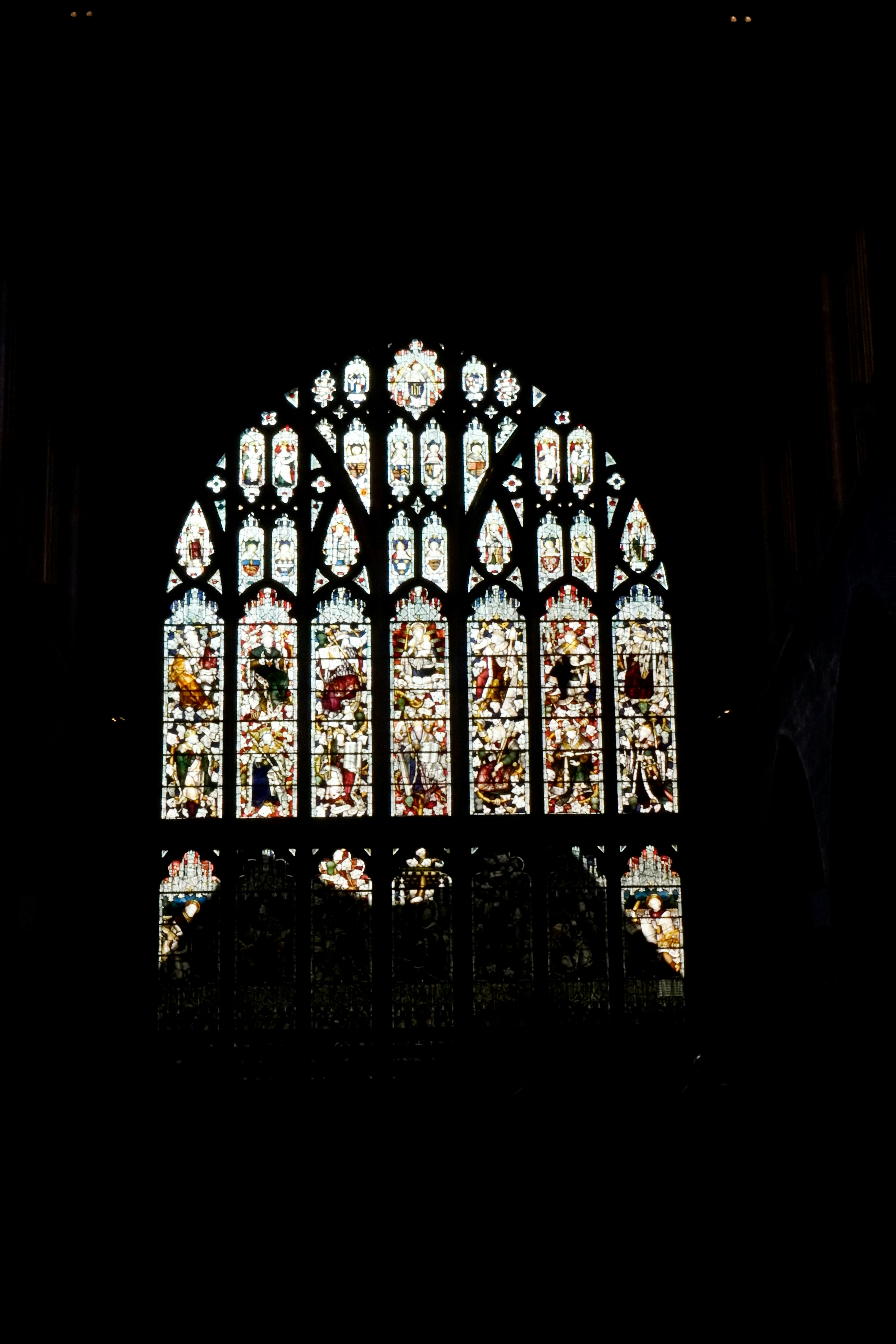 Stained Glass Window in a Dark Cathedral