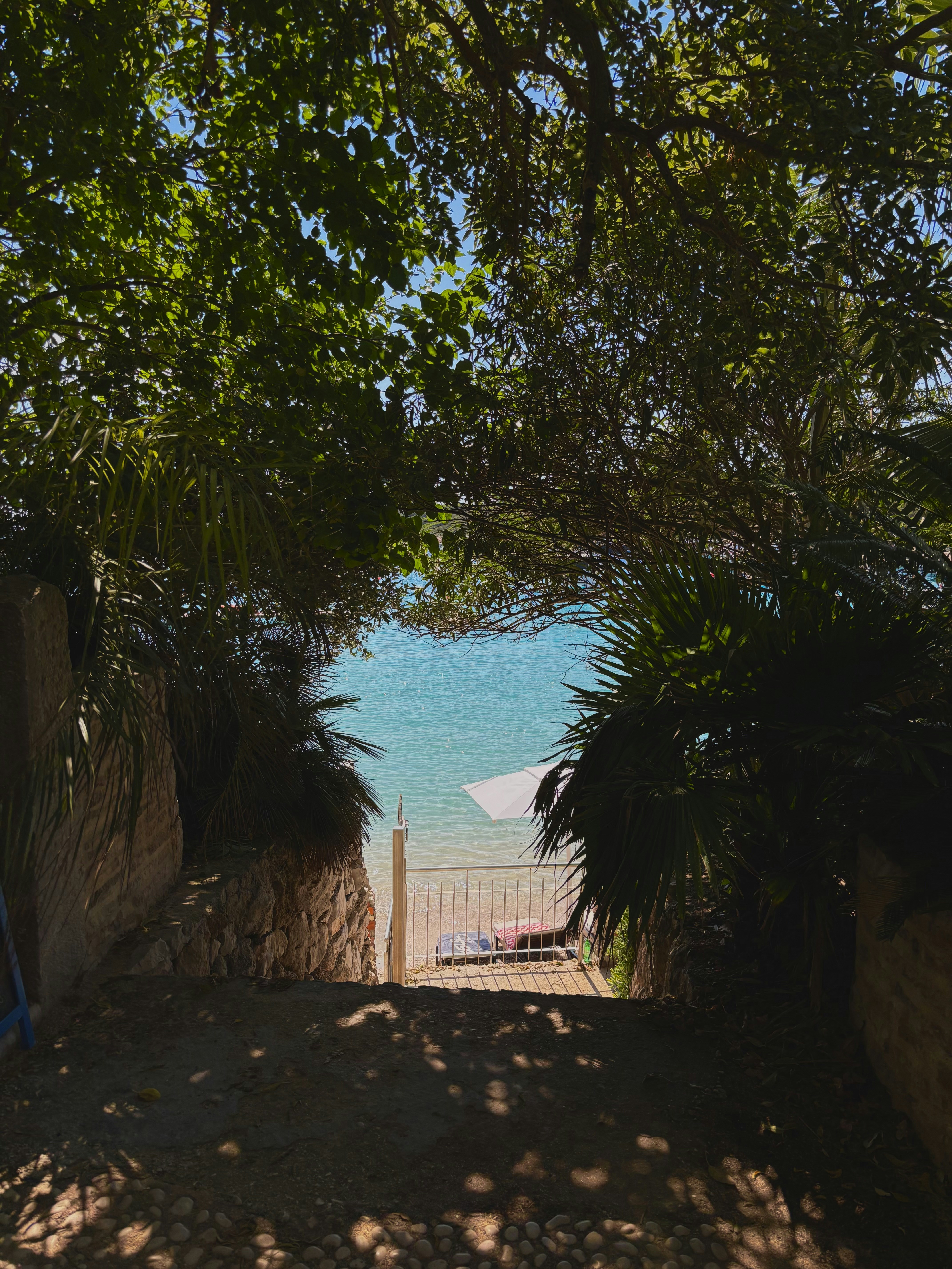 Sunlit Beach Gate: A Tranquil Path to the Sea