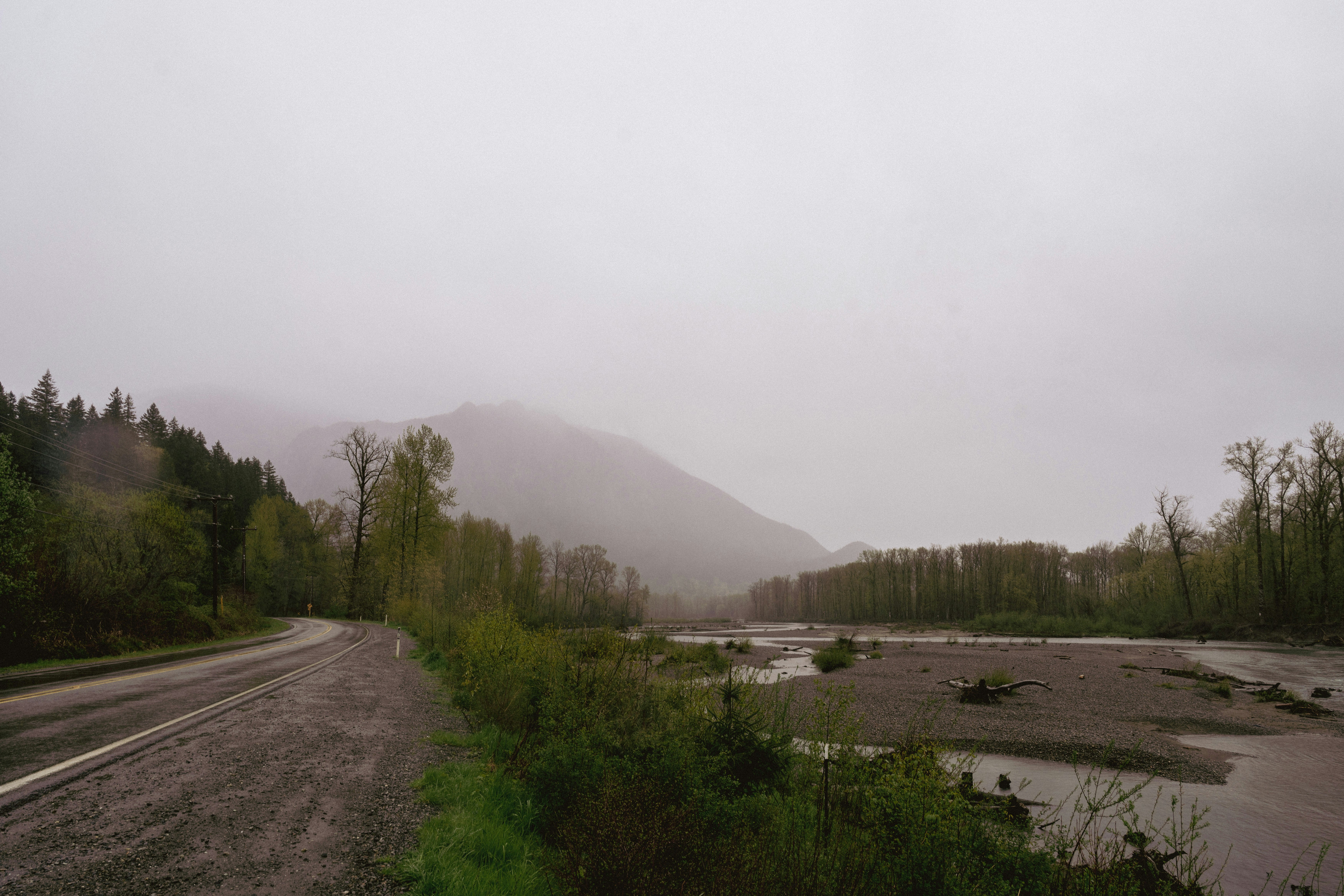 Mist-Softened Valley Road Along a Highland River