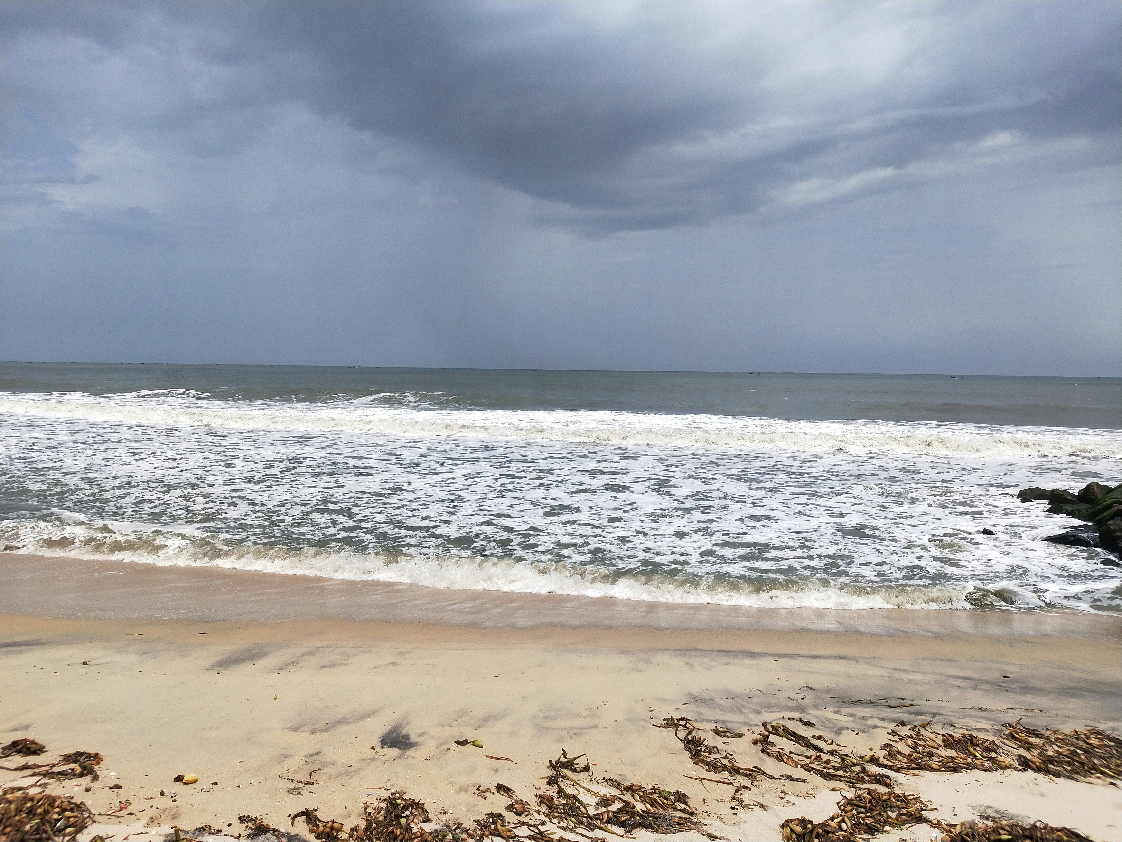 Foamy shoreline under brooding sky