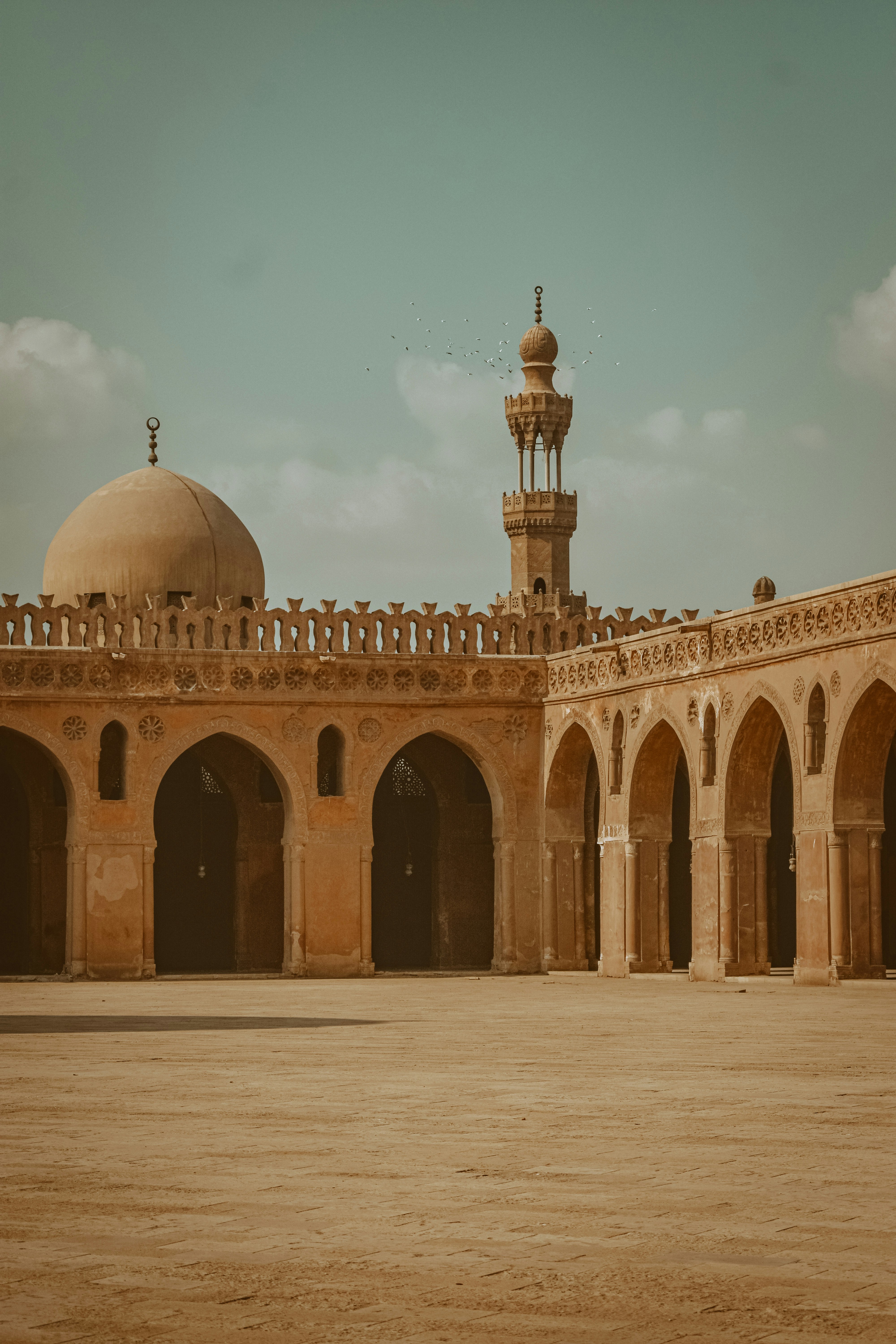 Sultan's Courtyard: Archways and Dome Under Gentle Sky