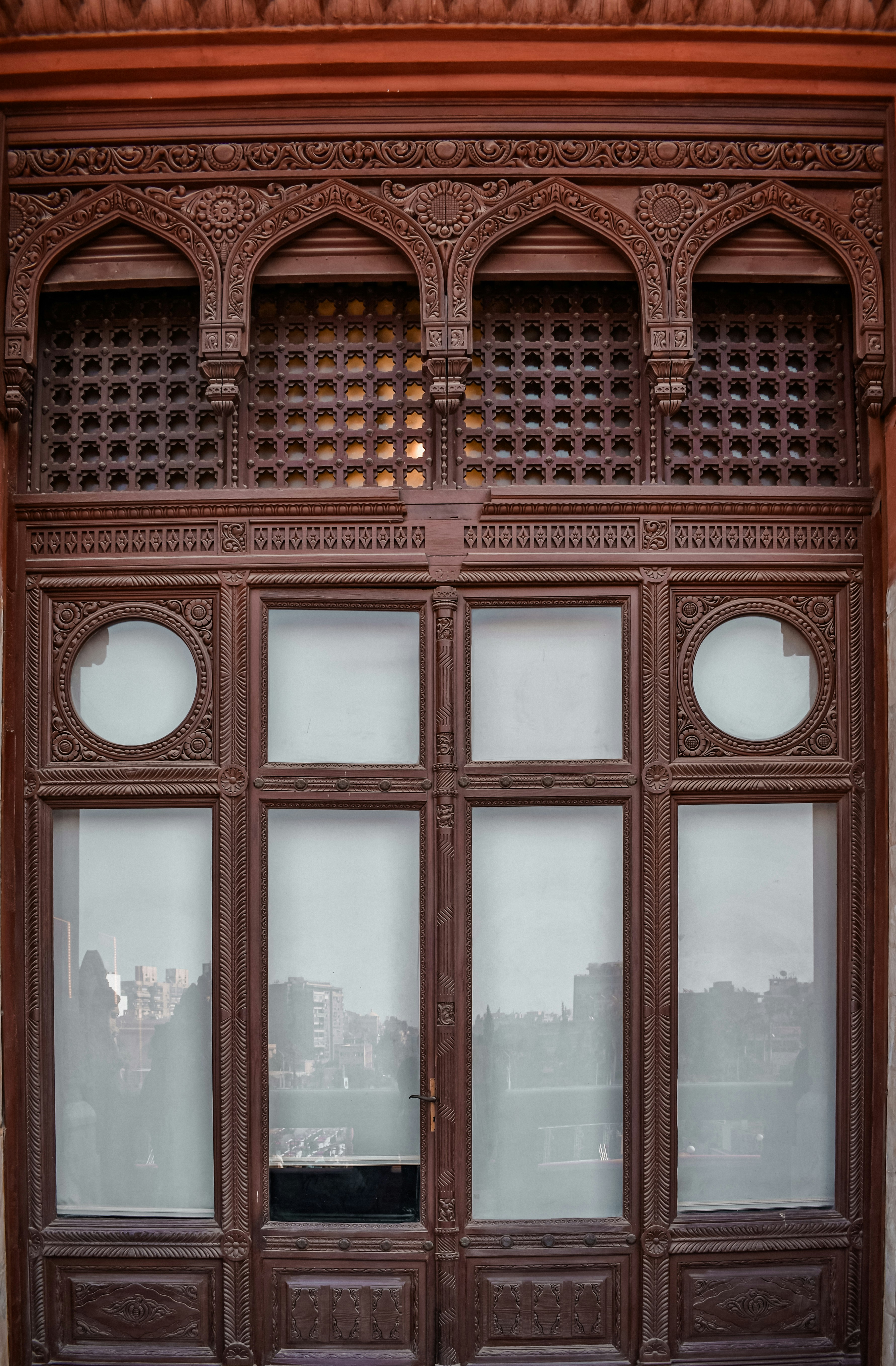 Ornate Doorway of Time: Carved Frames and Frosted Windows