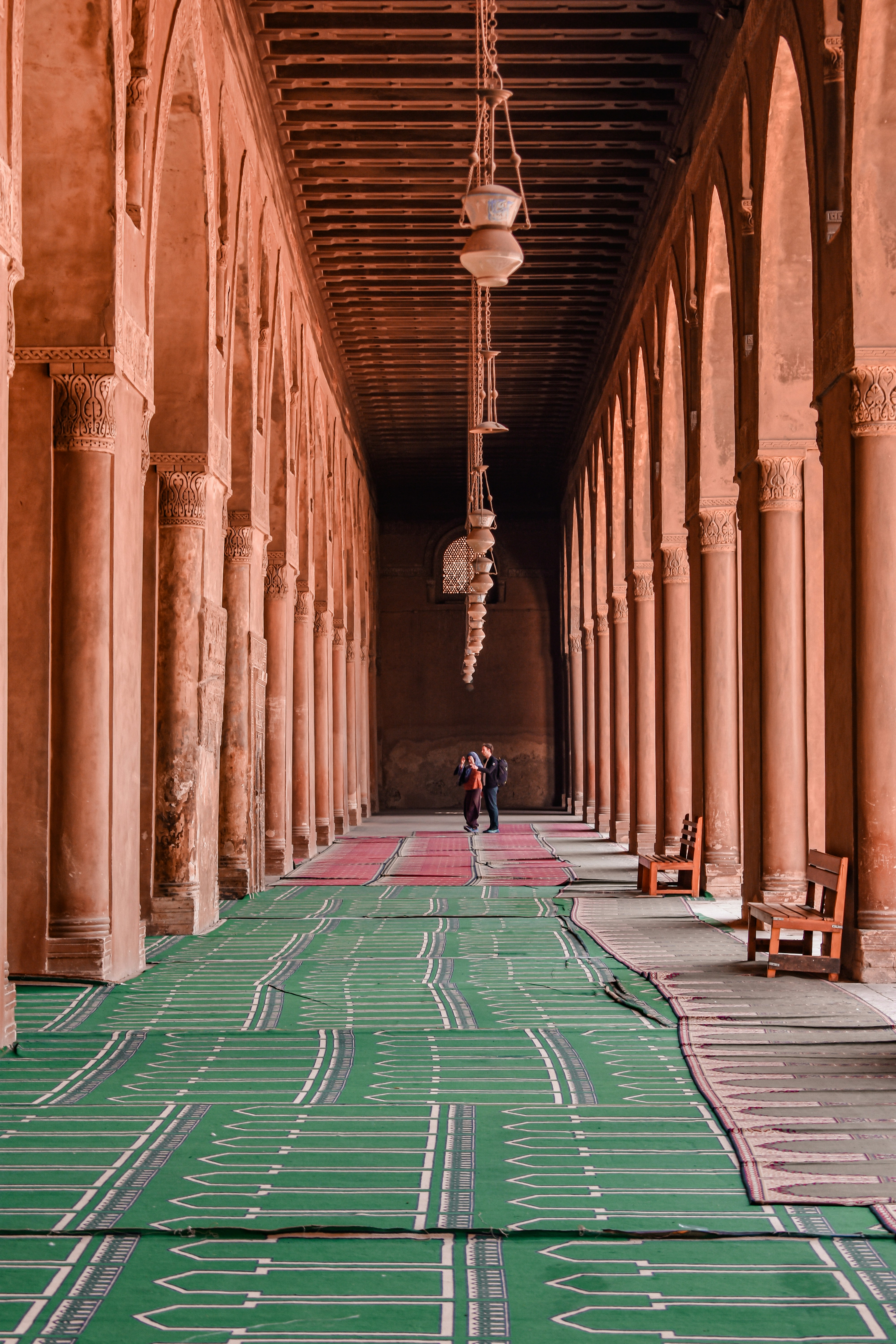 Long Shadowed Aisle: A Pair of Travelers in a Desert Hall