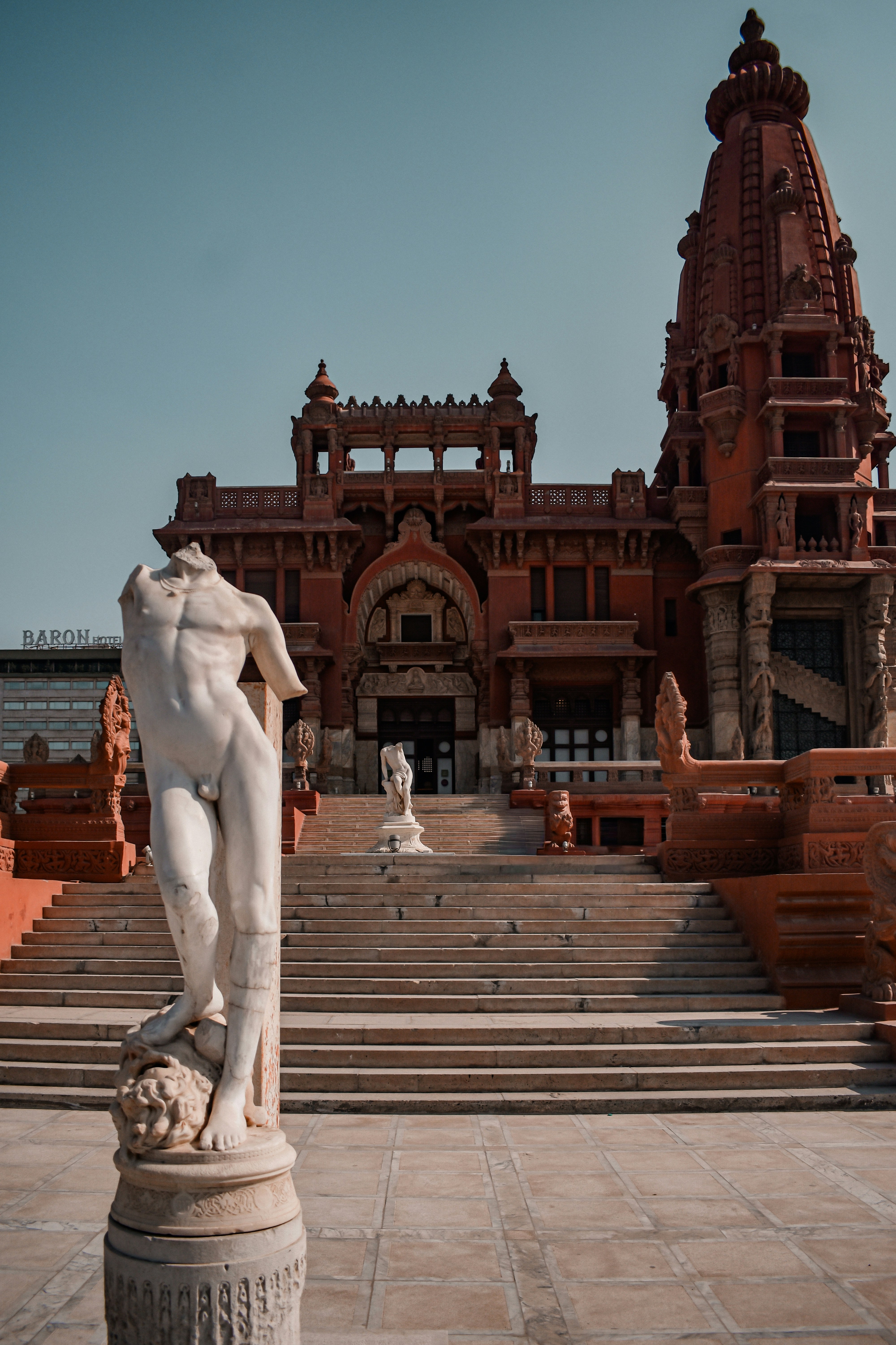 Statues Guard the Steps to a Red Brick Shrine