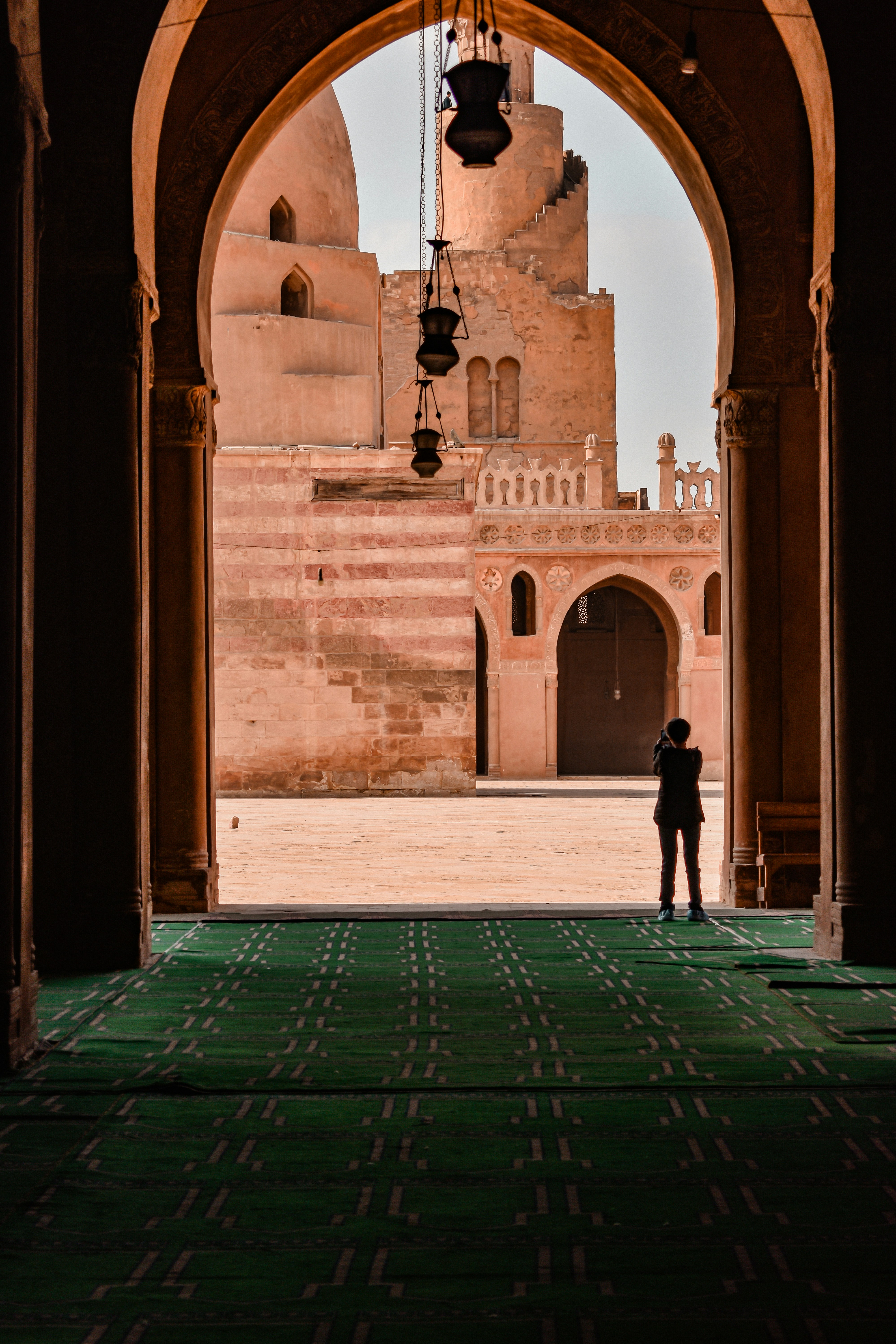 Archway Portrait: A Lone Figure in the Courtyard