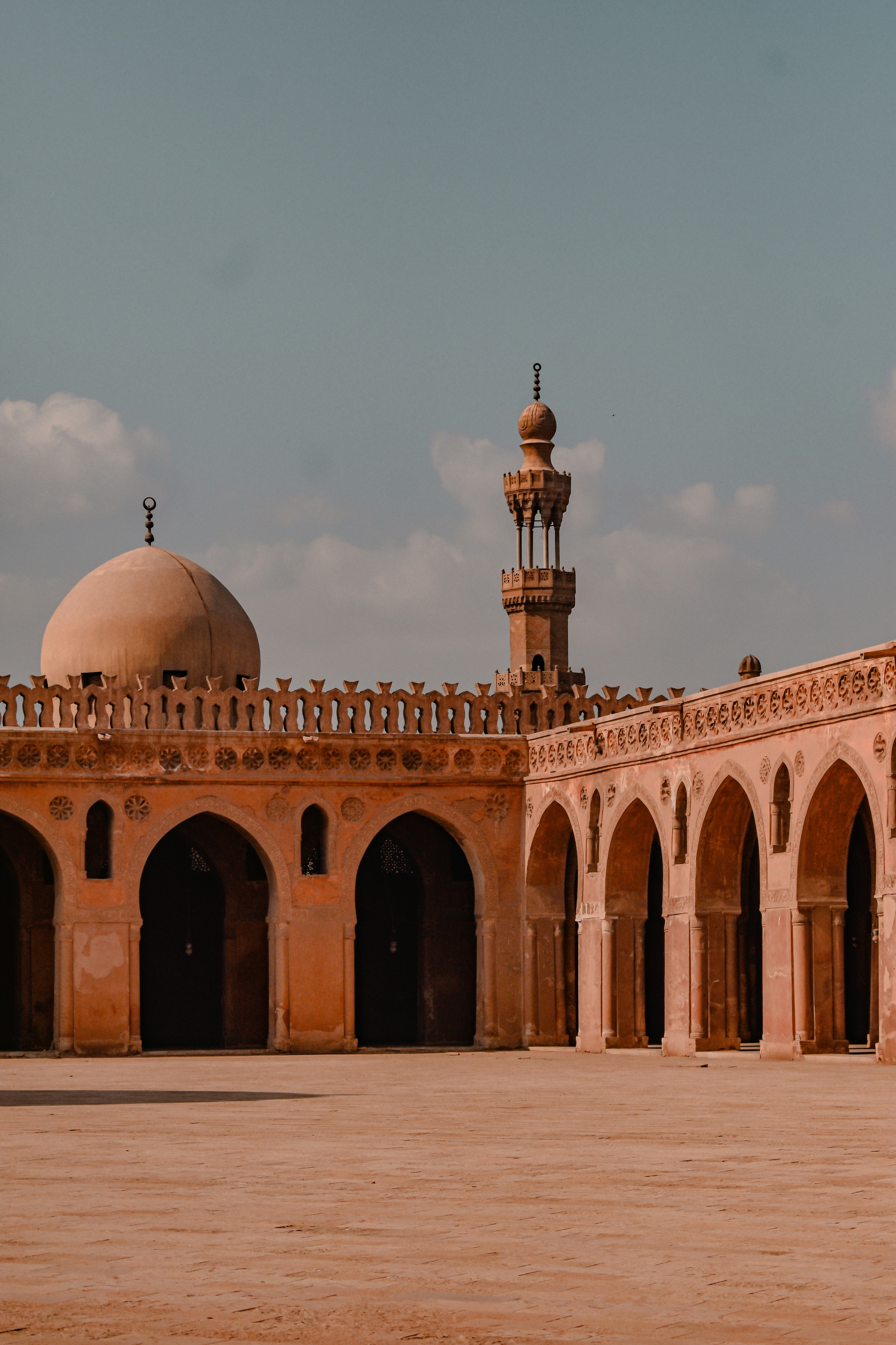 Courtyard of Stone Arches under a Cerulean Sky