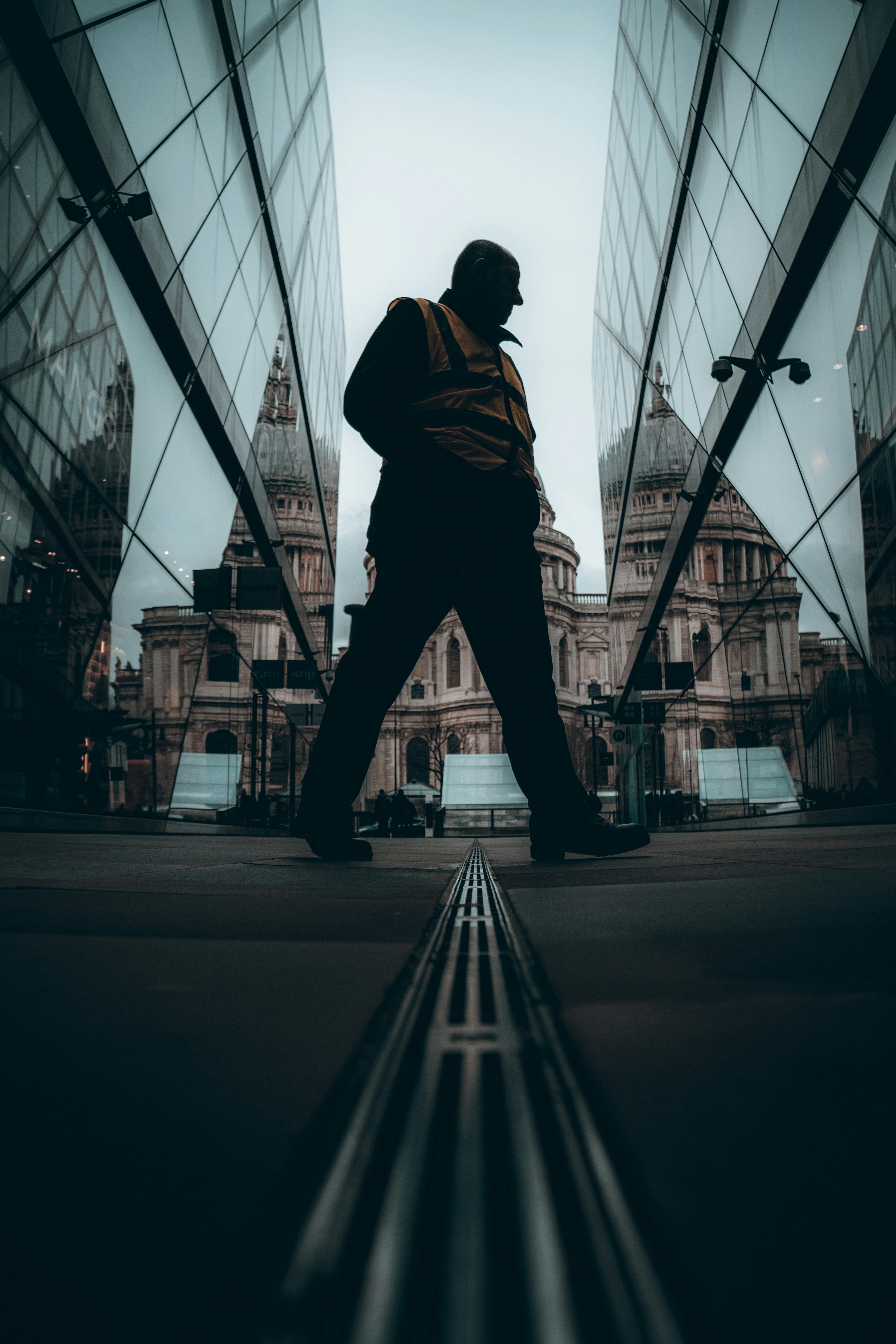 Stride Through Glass and Stone: A silhouette against Westminster’s Reflection