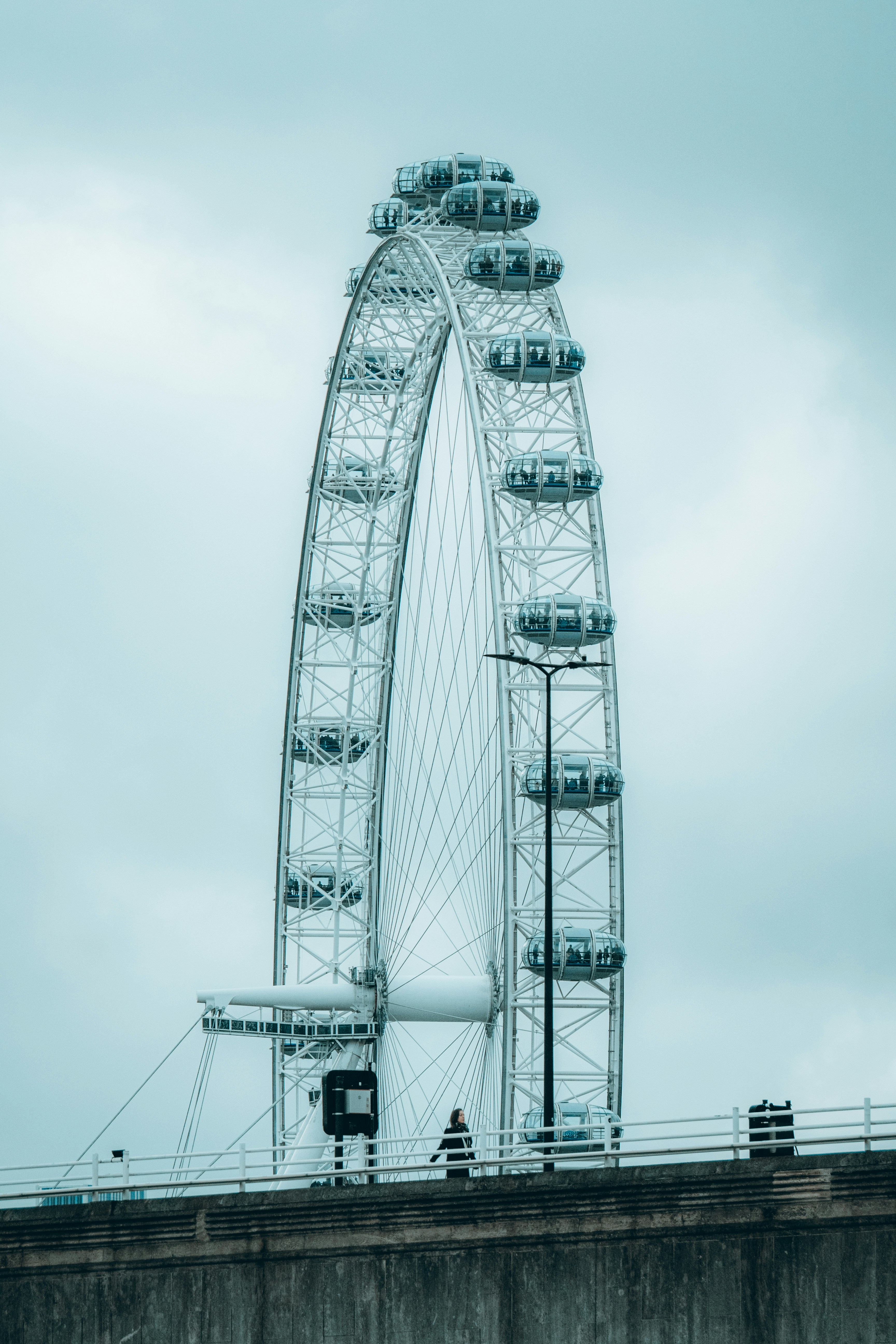 Giant Ferris Wheel Cutting the Sky Over the Riverside Walk