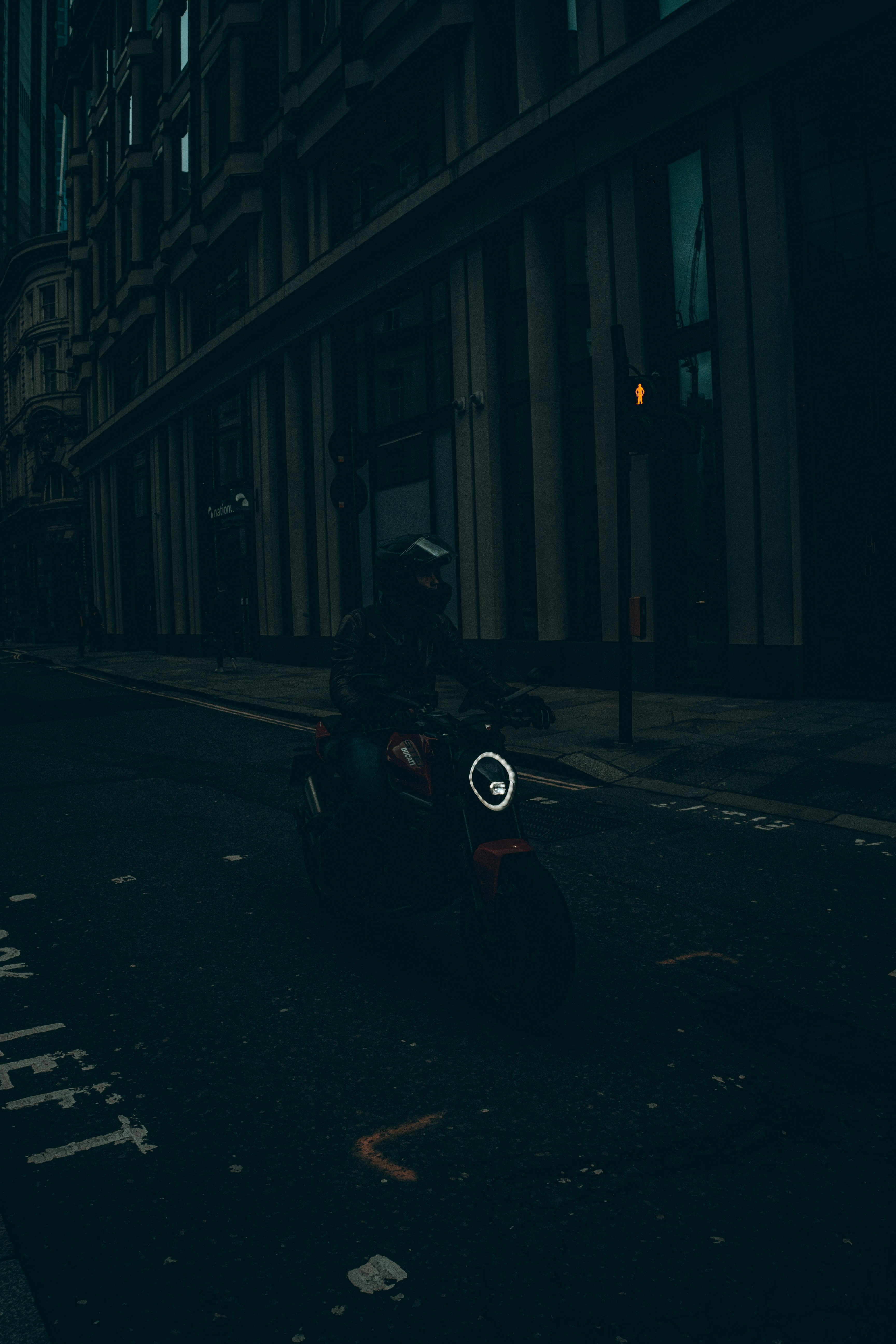 Low-light Rider: A Neon Ring Illuminates a Motorcycle in a Quiet City Night