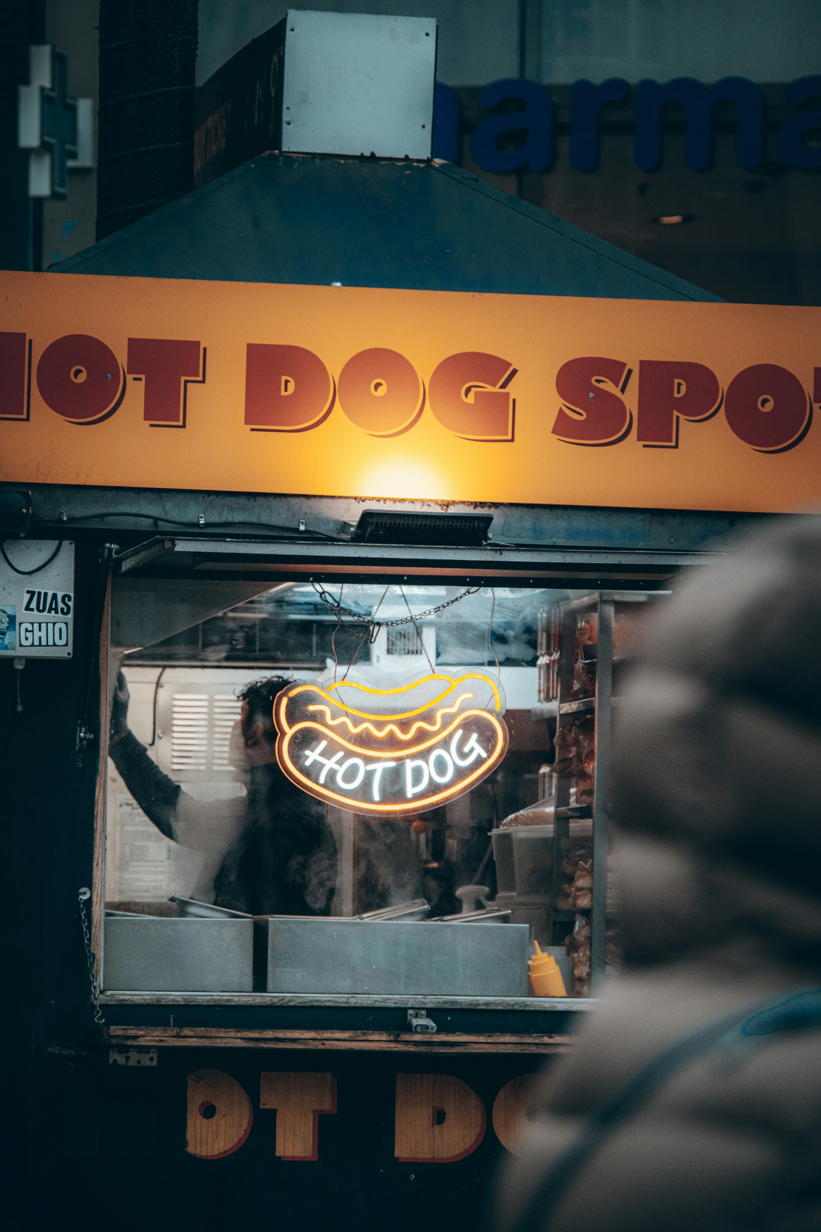 Hot Dog Stand Neon Amid City Blur