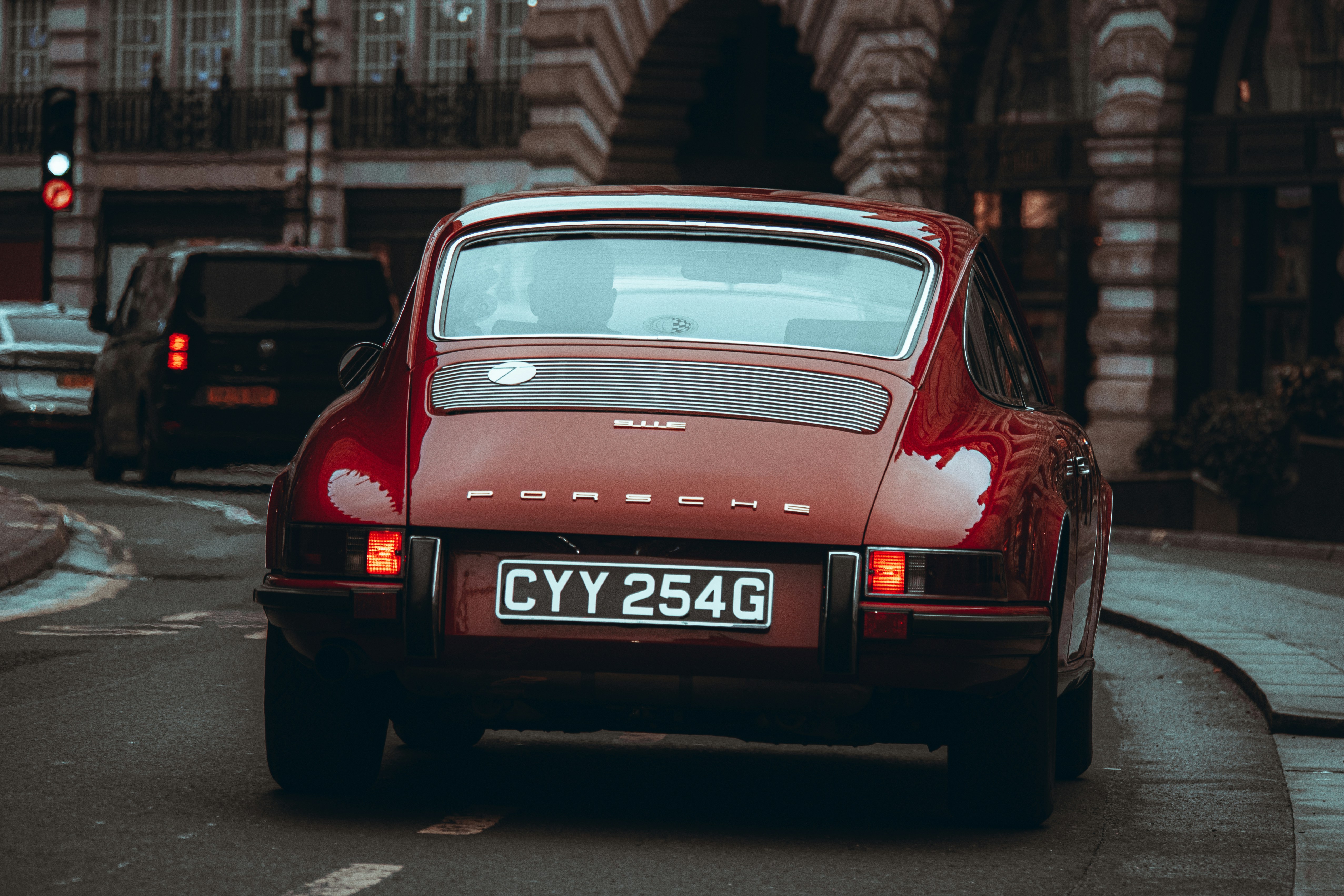 Red Classic: A Porsche 911 Bends Into the City Evening