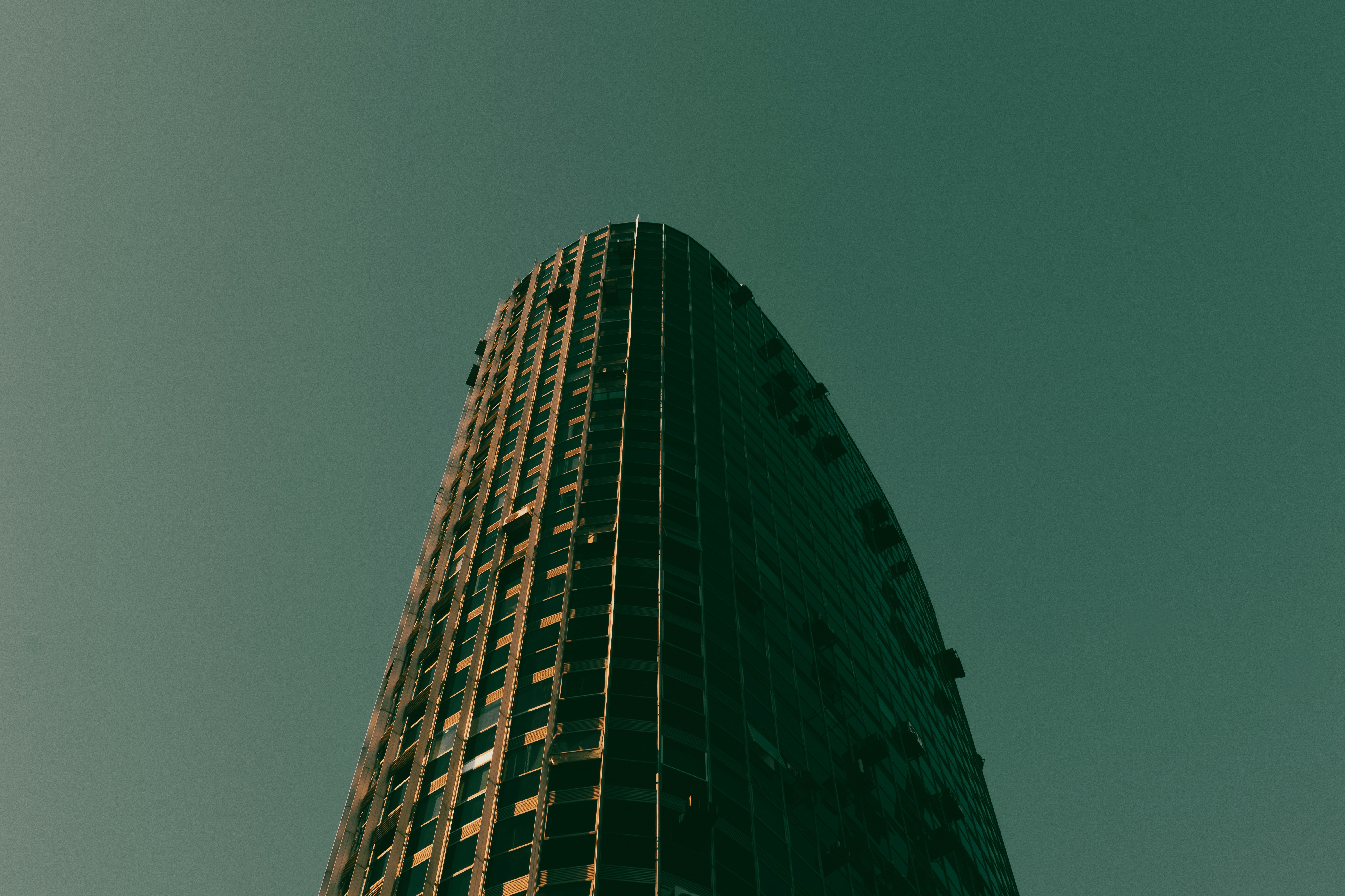 Gleaming tower crossing a teal sky