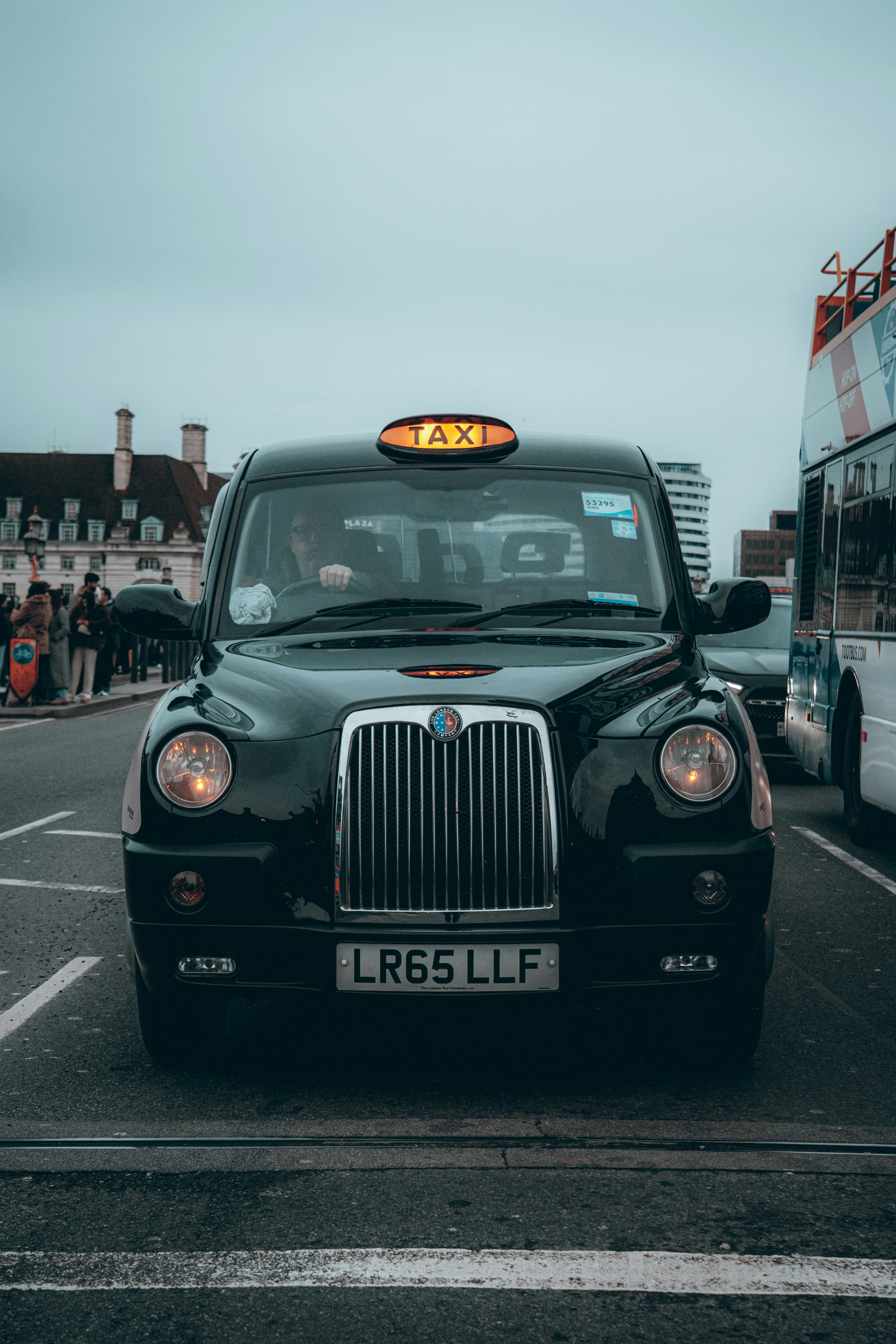 Taxi Front and Center: A London Cab Pair in Urban Overcast
