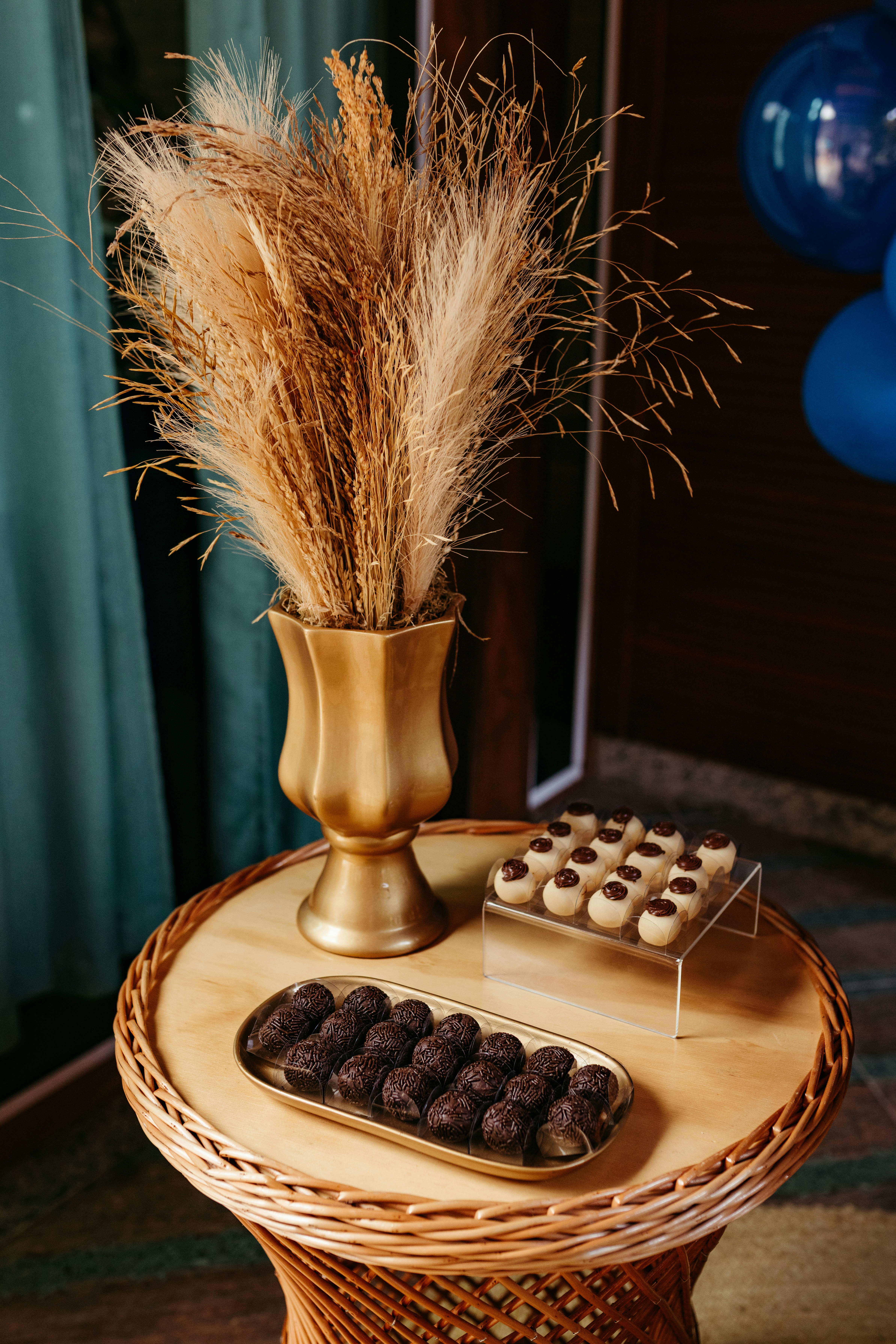 Gilded Vase and Night-Tinted Semisweet Treats on a Woven Pedestal