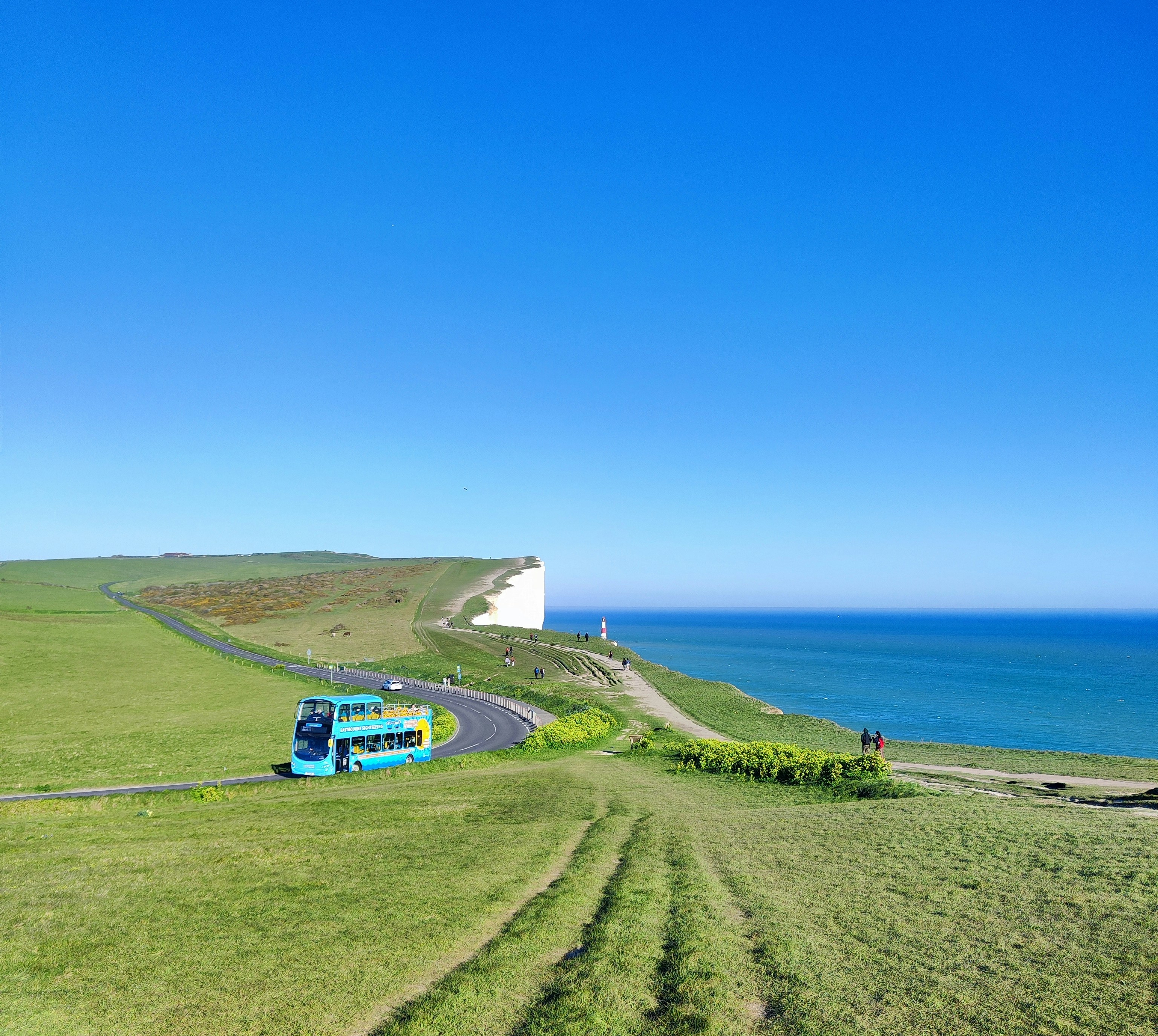 Coastal Cliffs and Blue Bus: A Scenic Atlantic Drive