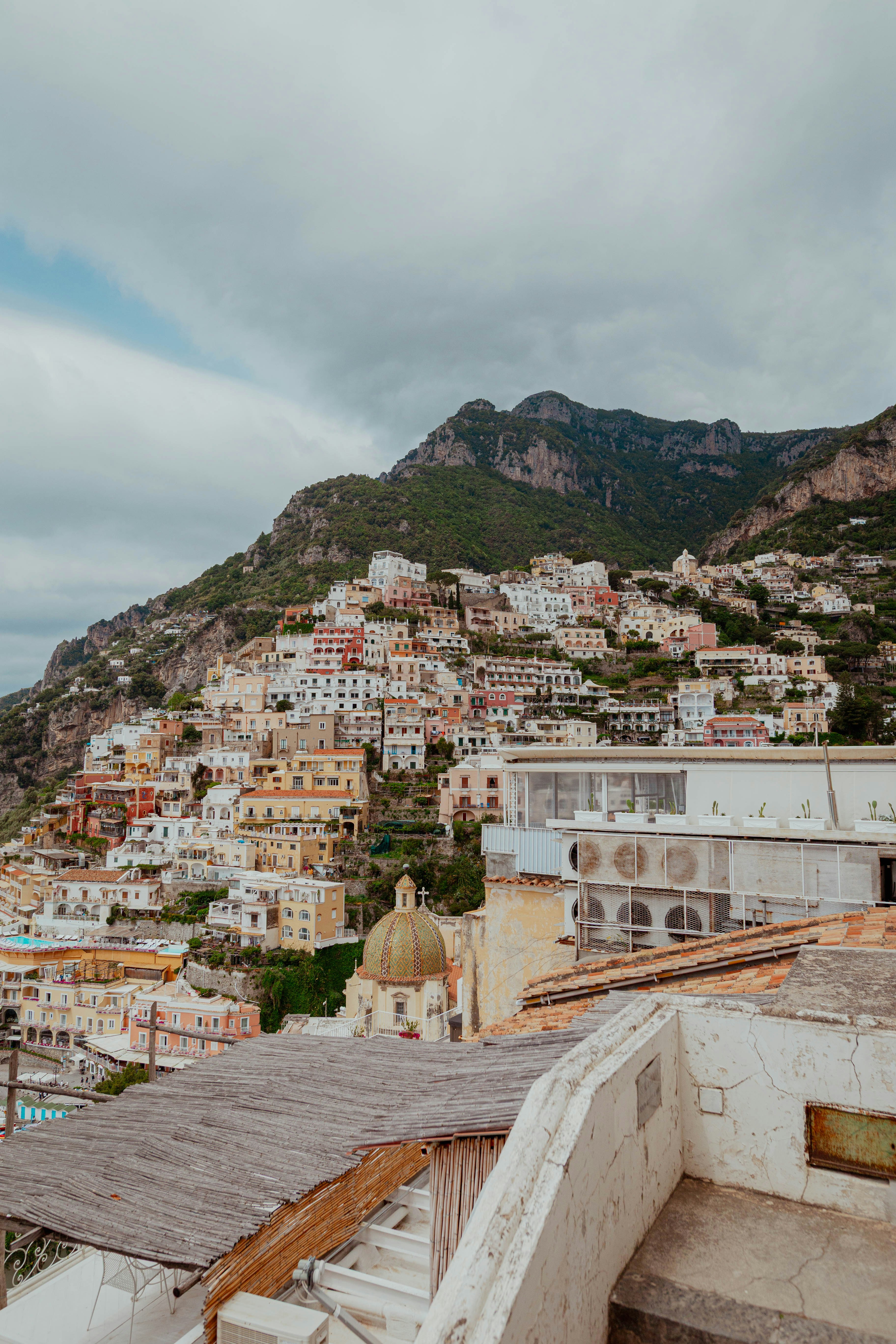Colorful cliffside village cascading down to the sea with a domed church