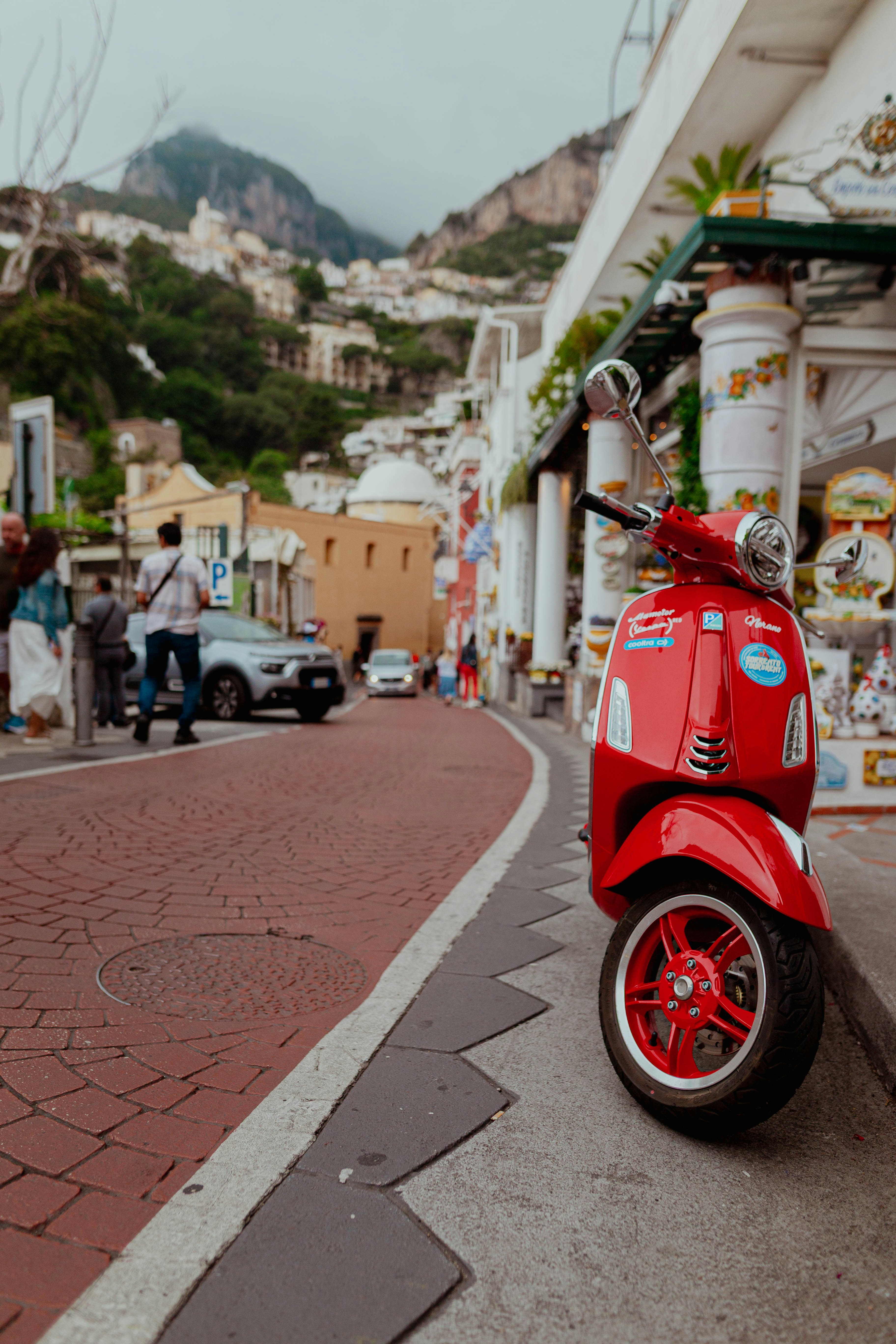 Red Scooter Quietly Guarding a Sunlit Street