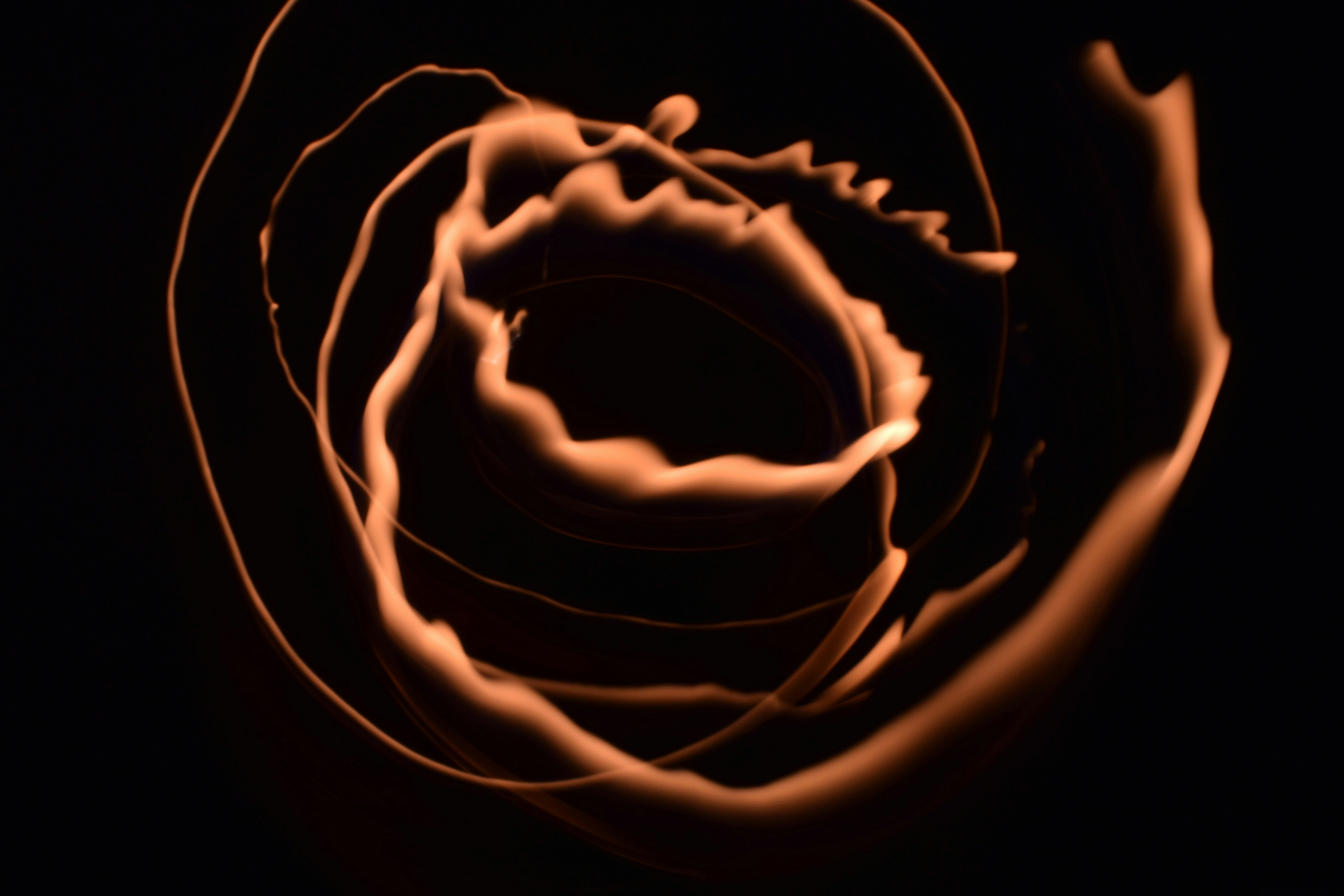 Spiral of Light: A Glowing Coil in Midnight Void