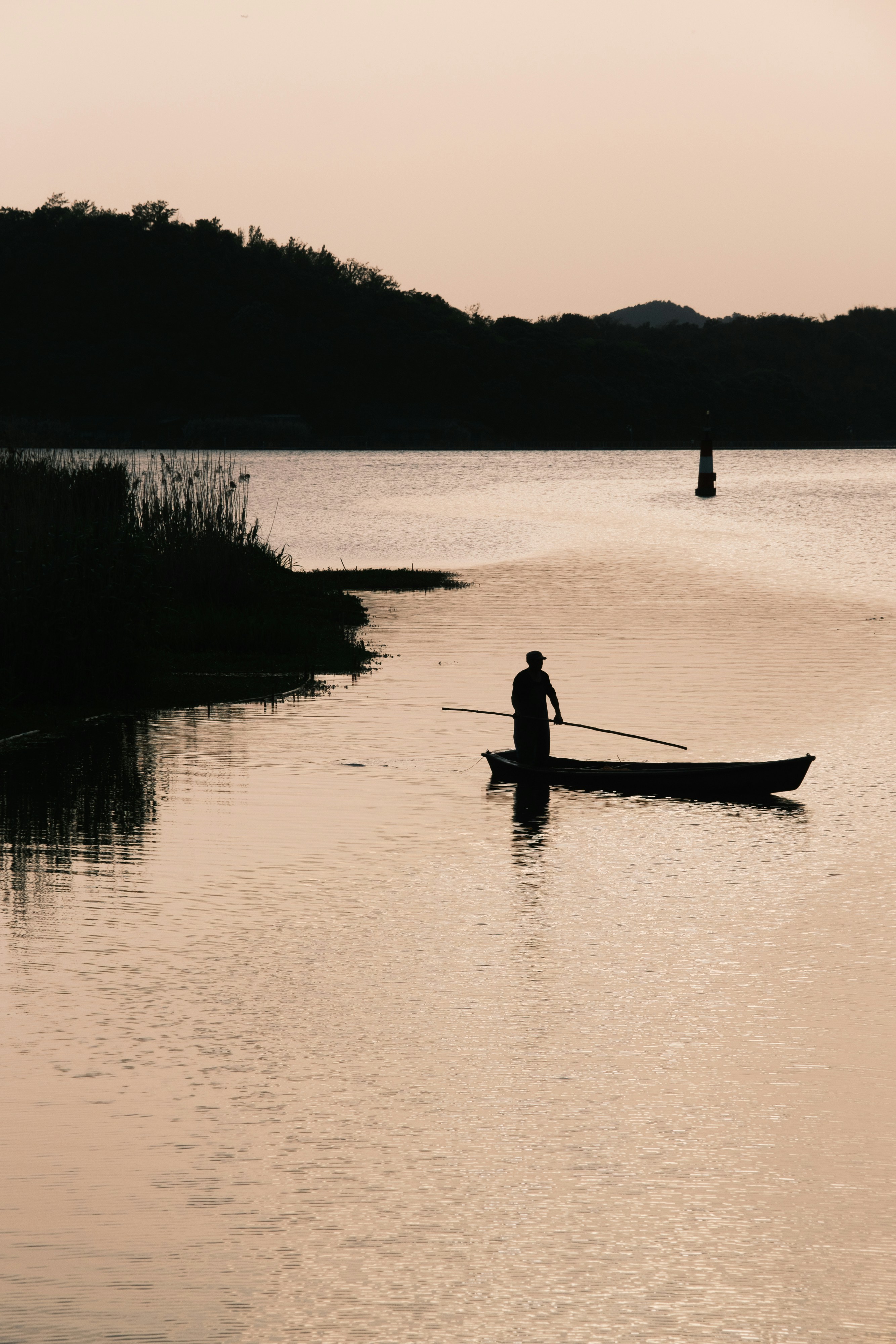 Silhouette across the Meridian: A Lone Boat at Dusk