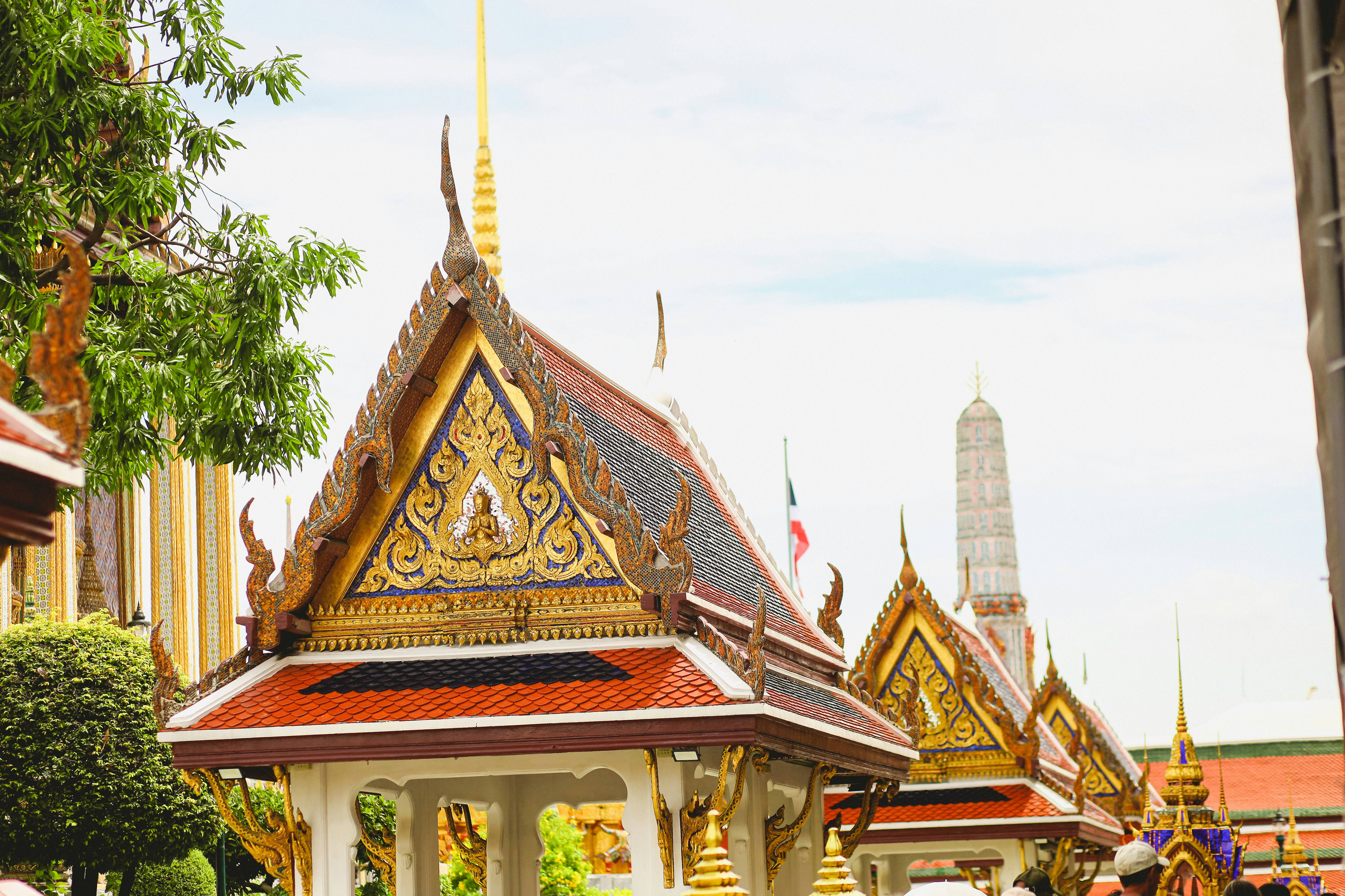 Golden Temple Roofs and Spires: A Thai-Buddhist Courtyard in Sunlit Harmony