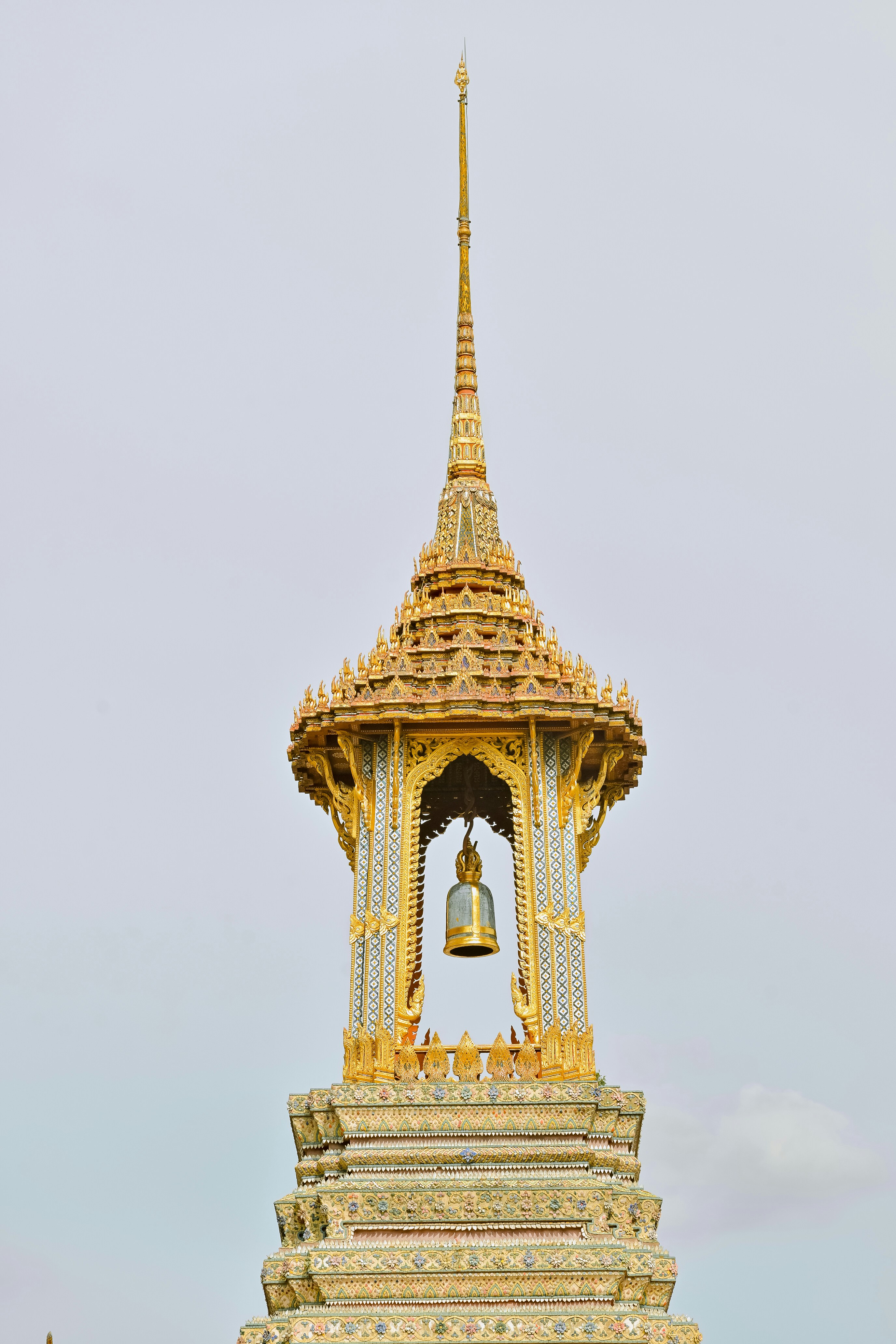 Golden Spire of Serenity: A Bell-Topped Temple Tower Rising Against a Soft Sky