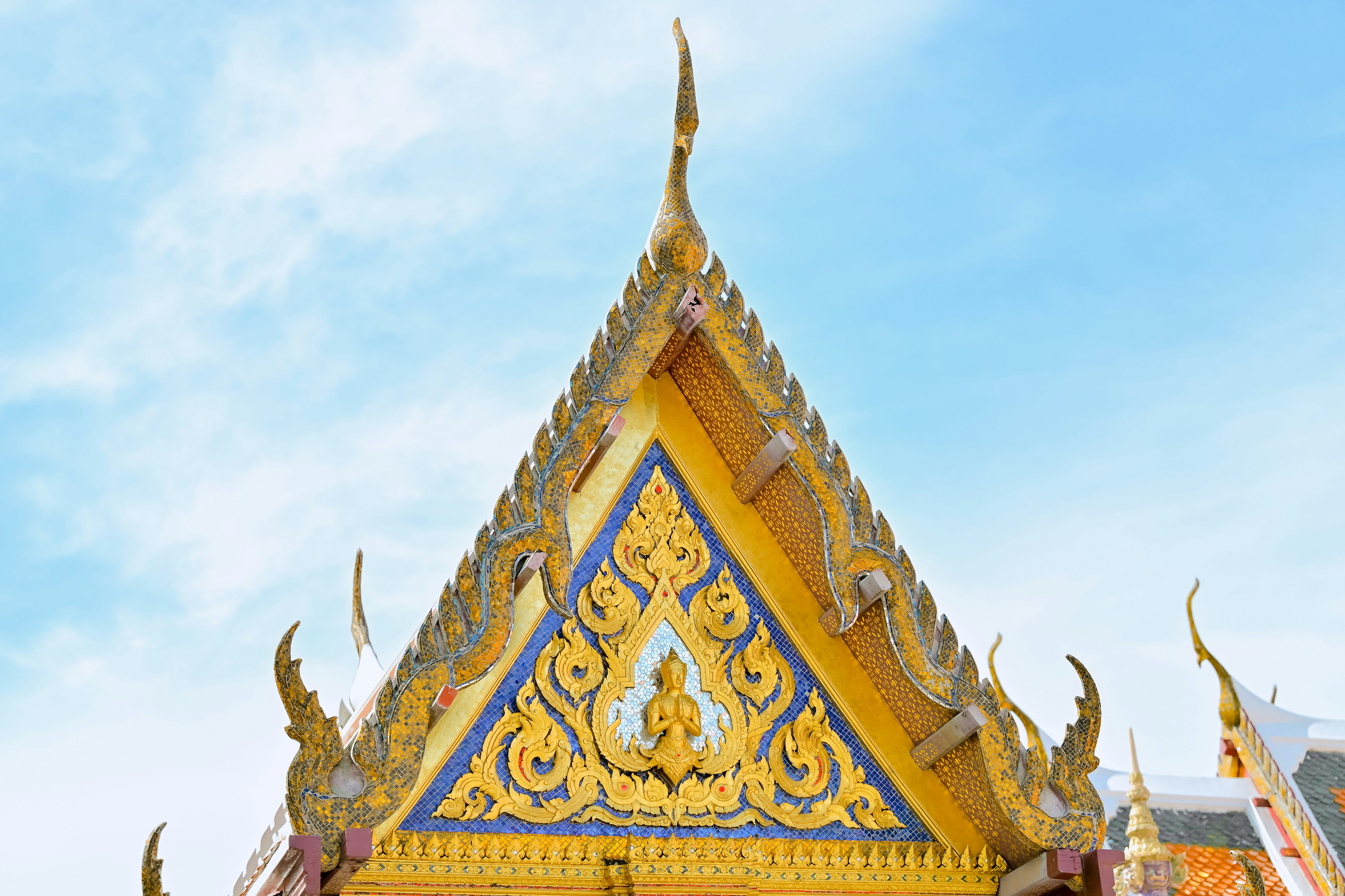 Golden Temple Peak: Ornate Roof Framed by Azure Sky